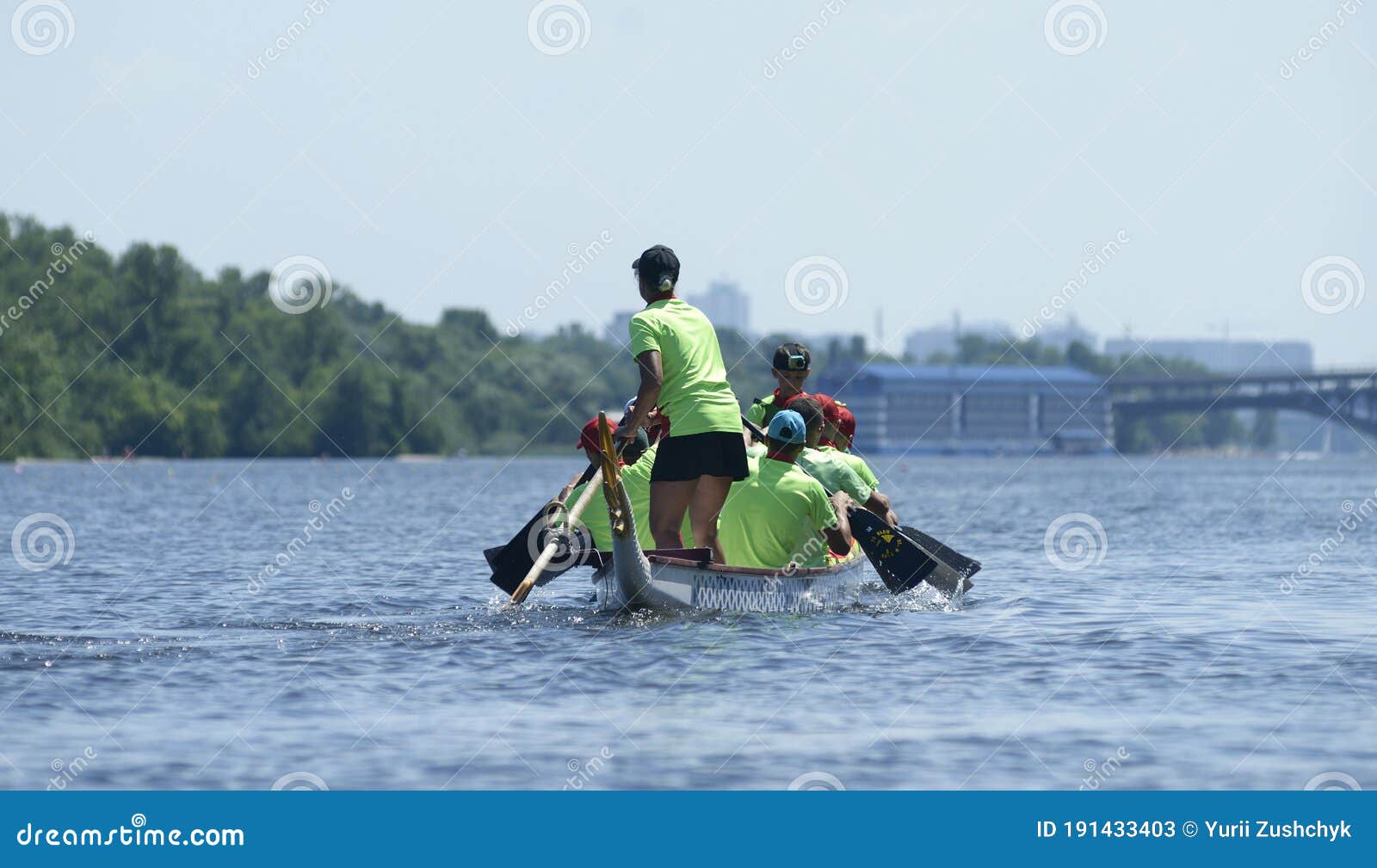 Oarsmen Rowing a Dragon Boat on a River. Kiev Oblast Championship among ... Oarsmen Rowing a Dragon Boat on a River. Kiev Oblast Championship among ...