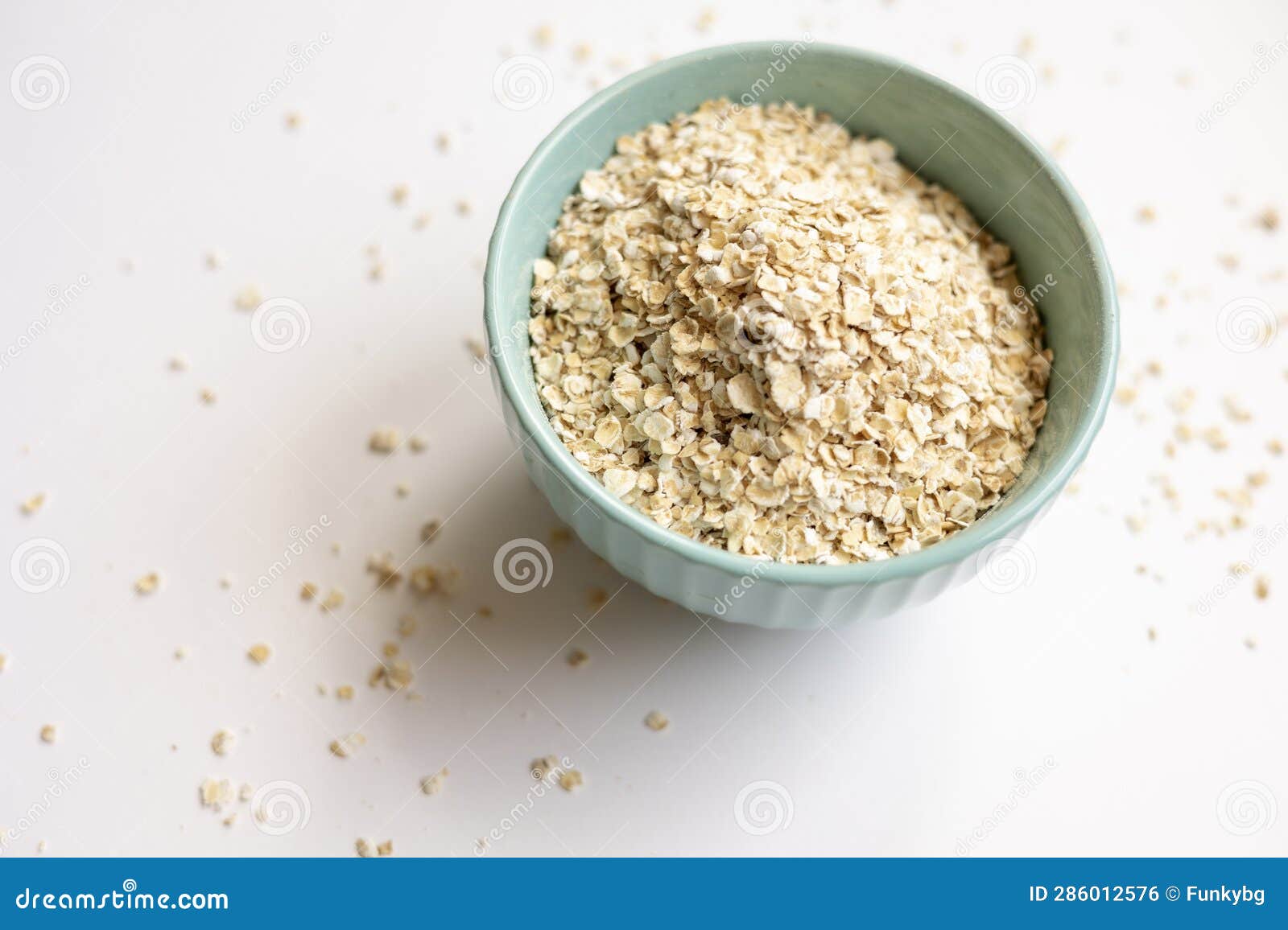 Oats in a Small Blue Bowl Isolate on White Background Closeup Stock ...