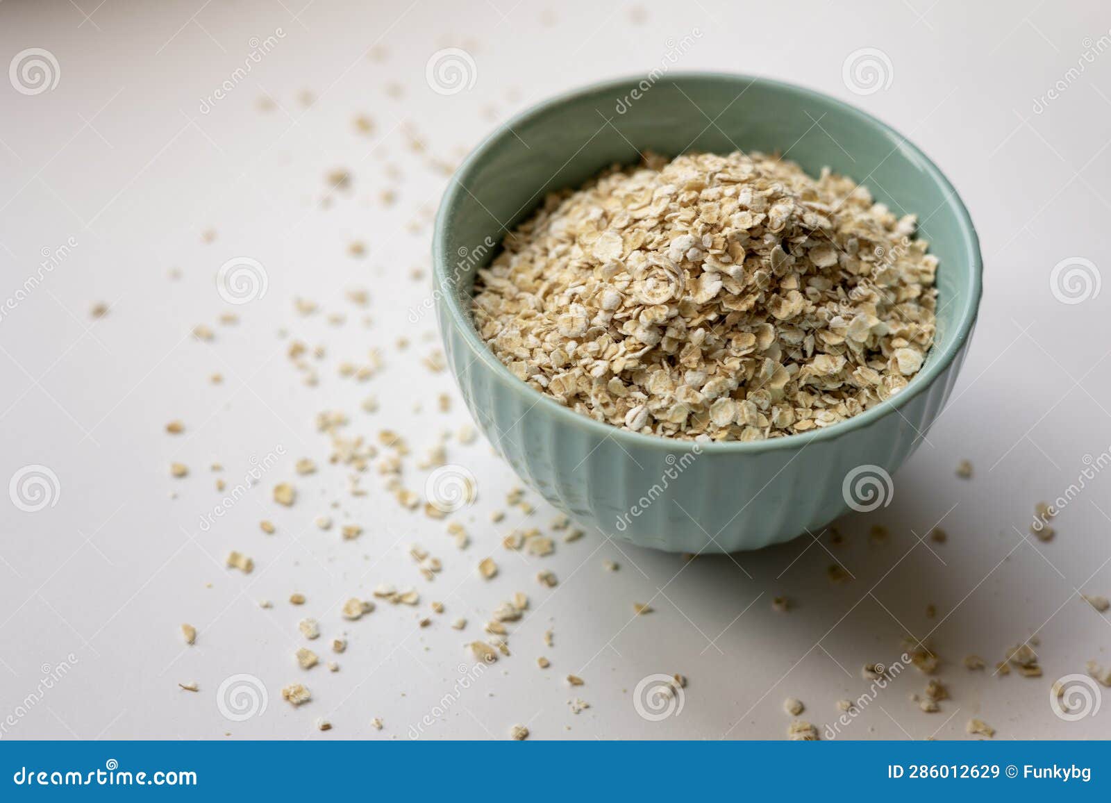 Oats in a Small Blue Bowl Isolate on White Background Closeup Stock ...