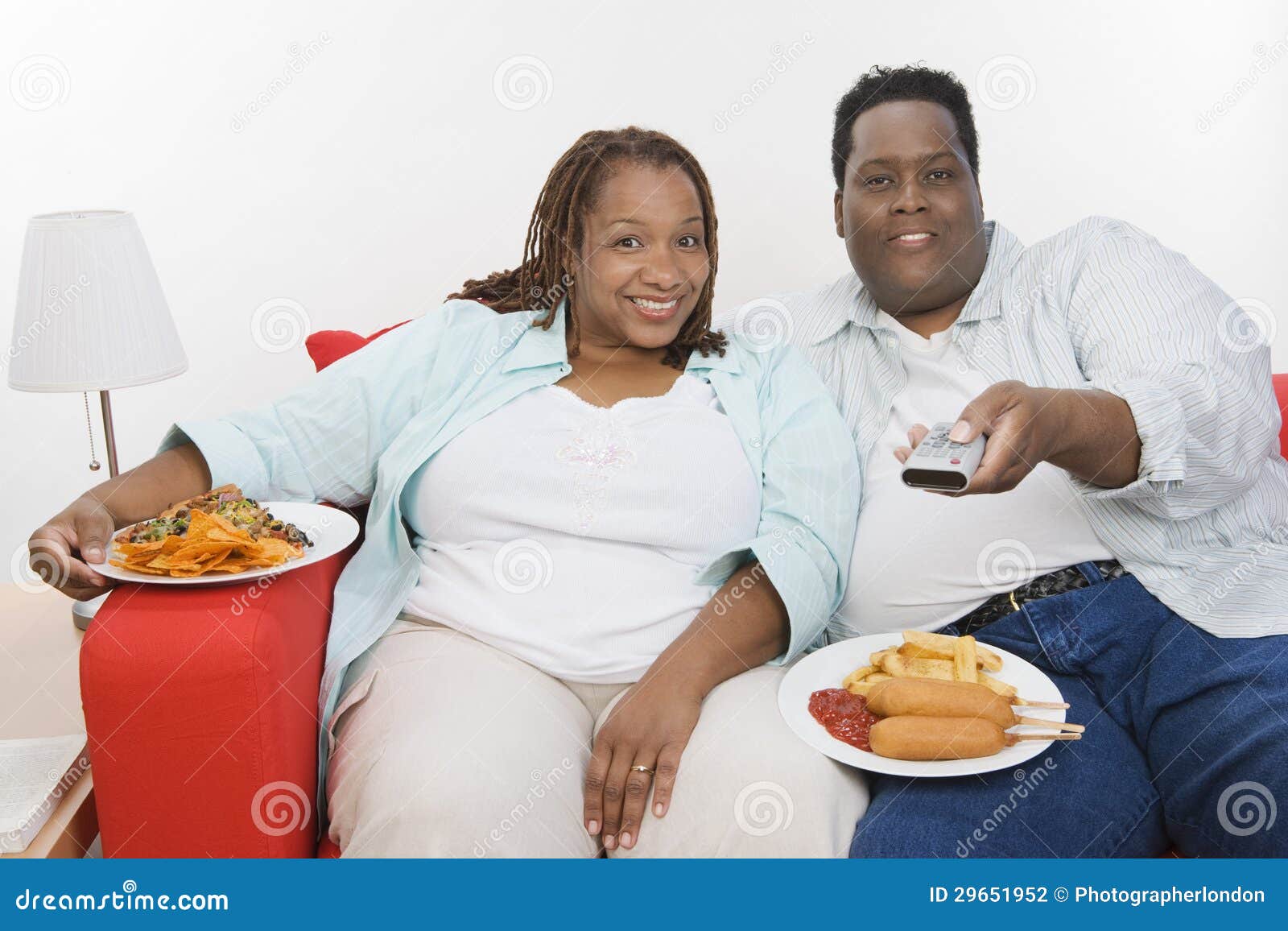 Obese Couple Sitting Together Stock Photo - Image of holding, indoors ...