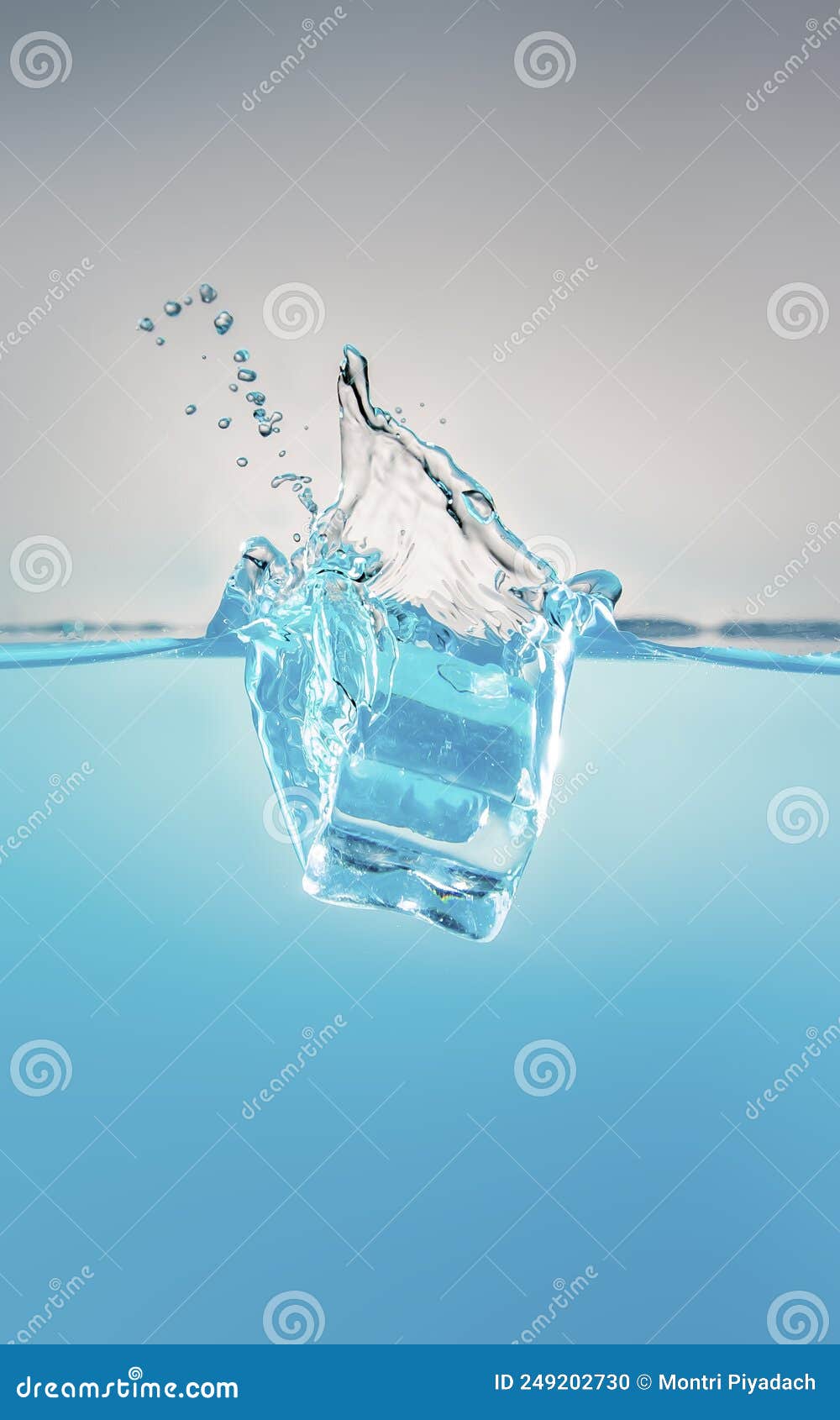Object Falling into Blue Water until Splashing on a Gray Background ...