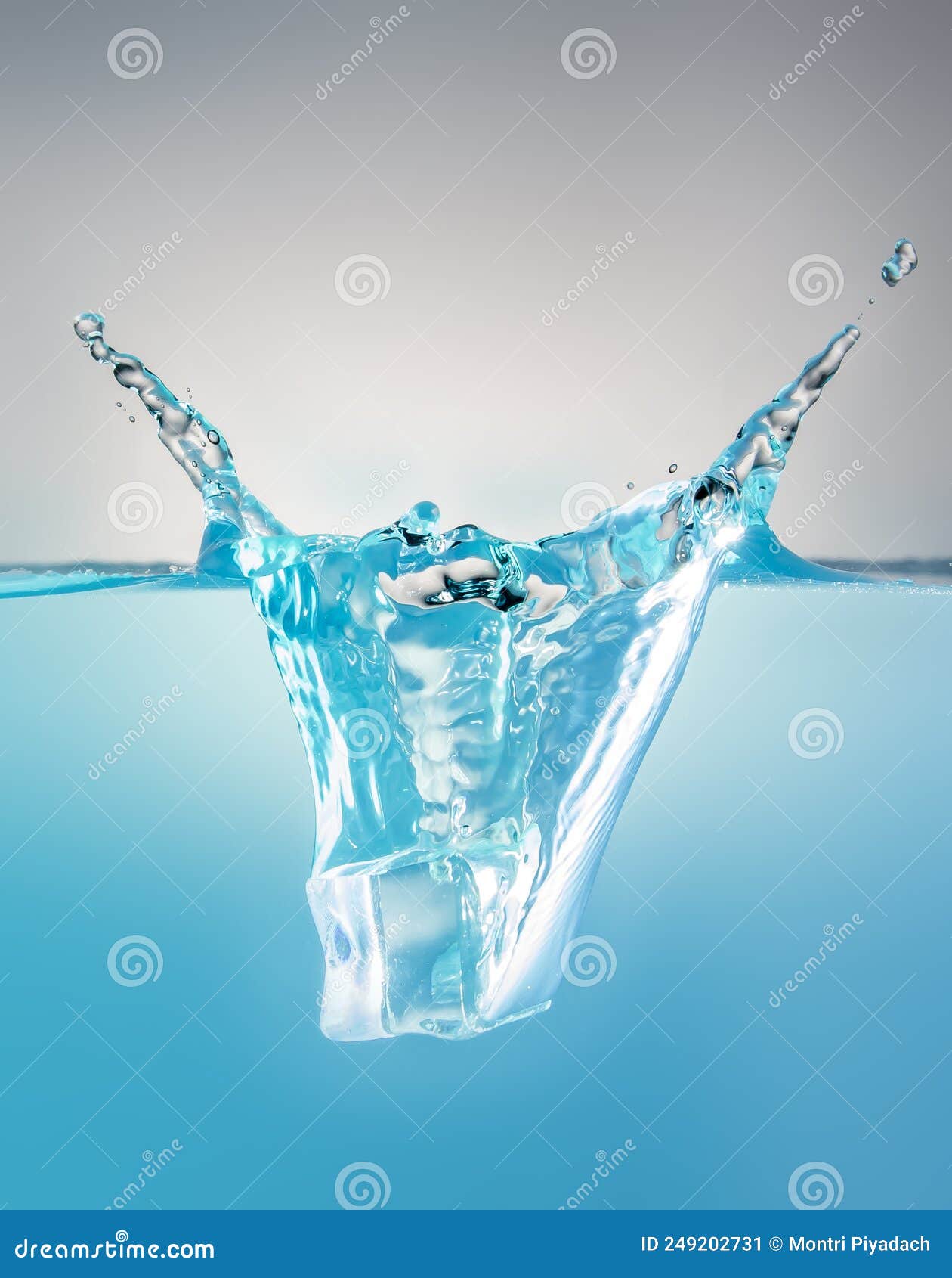 Object Falling into Blue Water until Splashing on a Gray Background ...