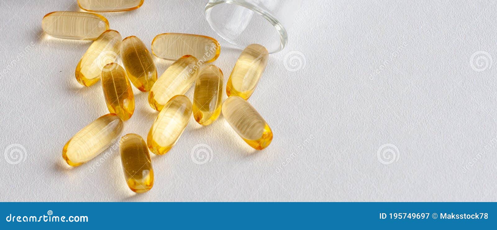 Oblong Yellow Vitamins are Scattered on the White Surface. a Place for ...