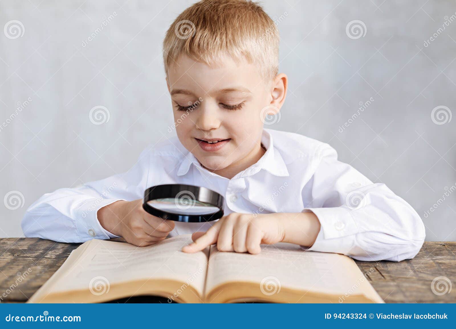 Observant Inventive Boy Using a Lens for Reading Stock Photo - Image of ...