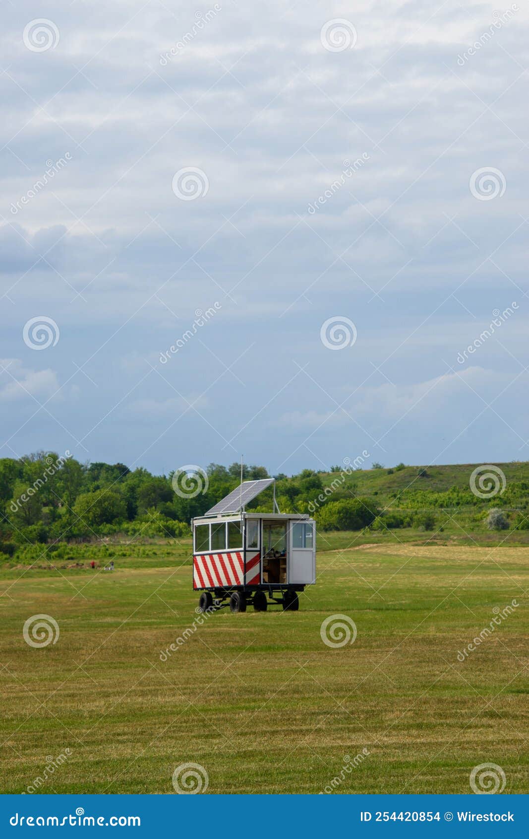 Observation Booth Working with Solar Panels in a Green Field Under ...