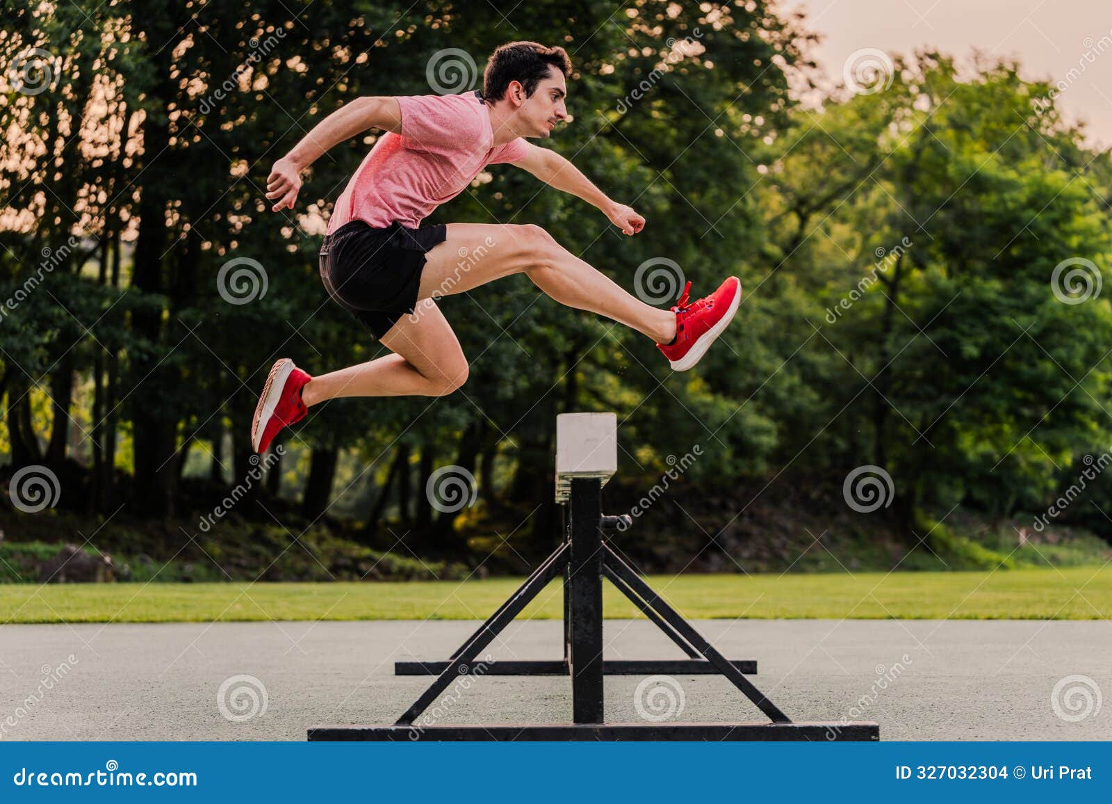 Obstacle Course Runner Jumping a Hurdle during Outdoors Training Stock ...