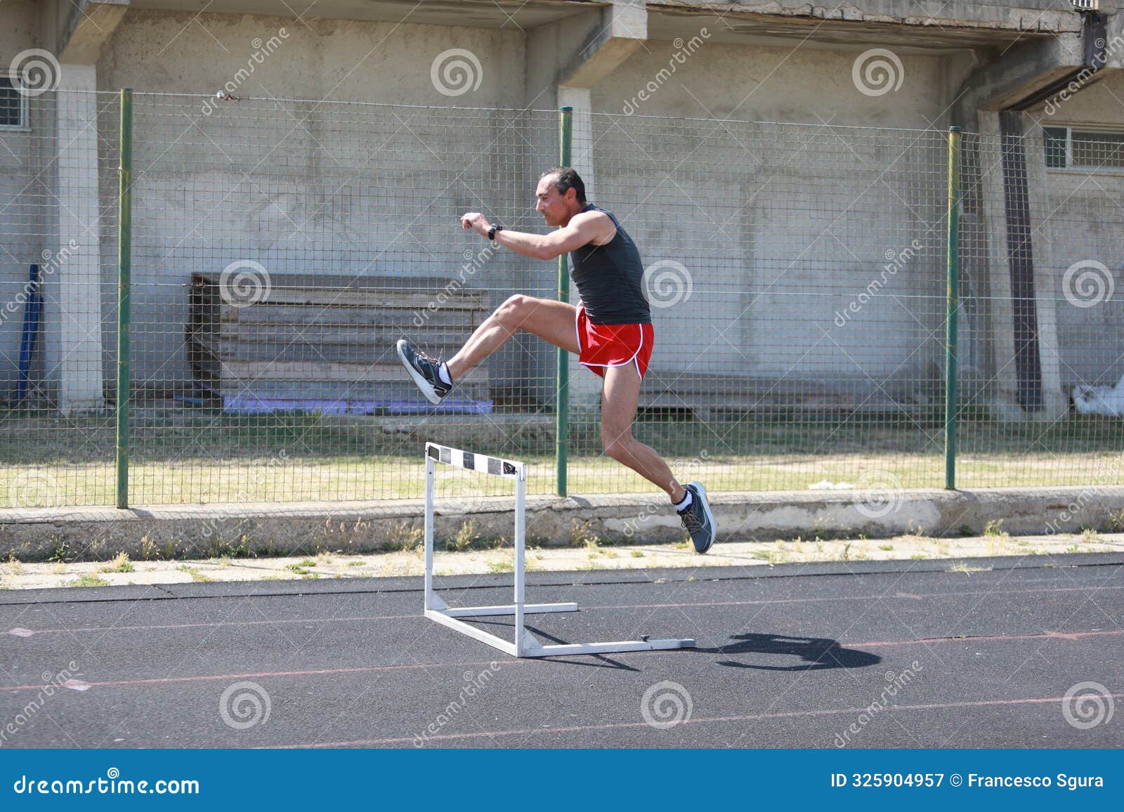 Obstacle Runner Jumping in the Stadium Track Stock Image - Image of ...