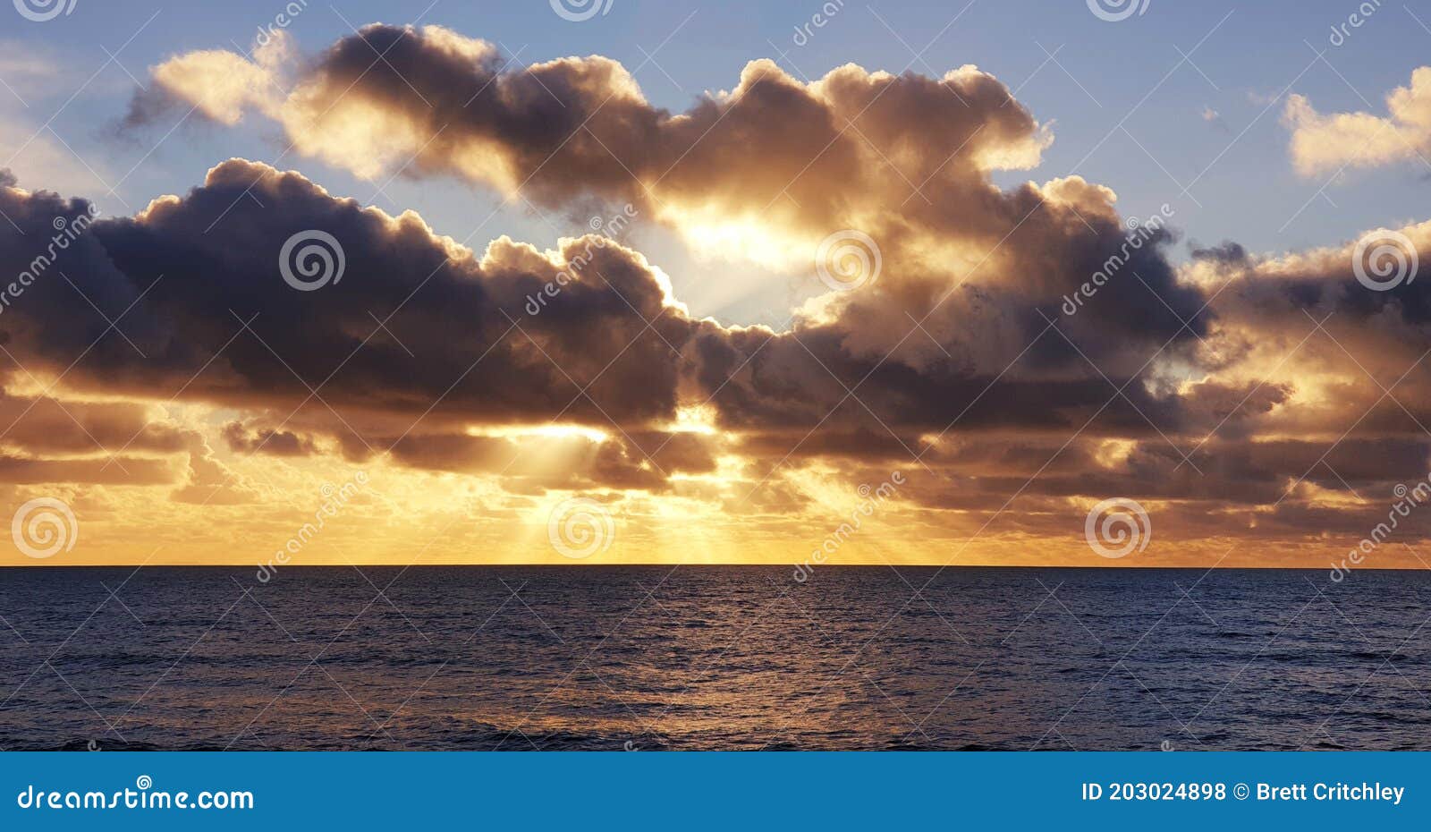 Ocean Beach Sunset with Rays of Sun Cloudburst Stock Photo - Image of ...