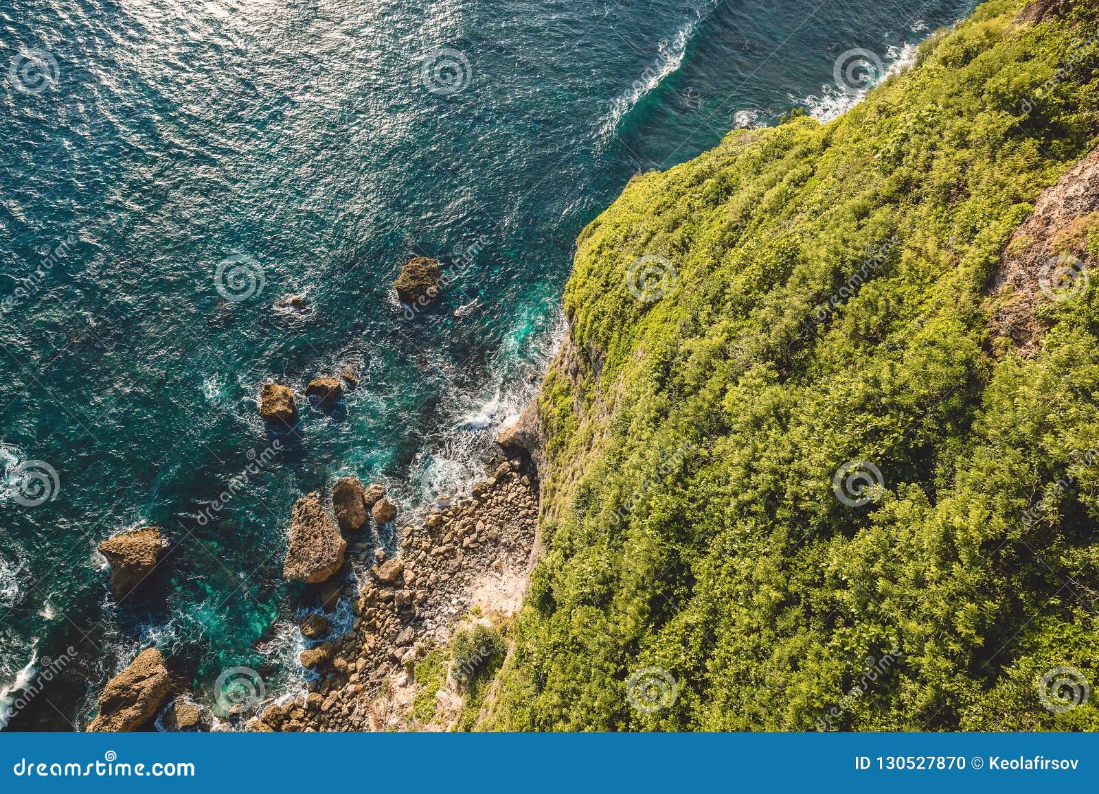 Ocean with Blue Water, Rocks and Cliff with Plants Stock Photo - Image ...