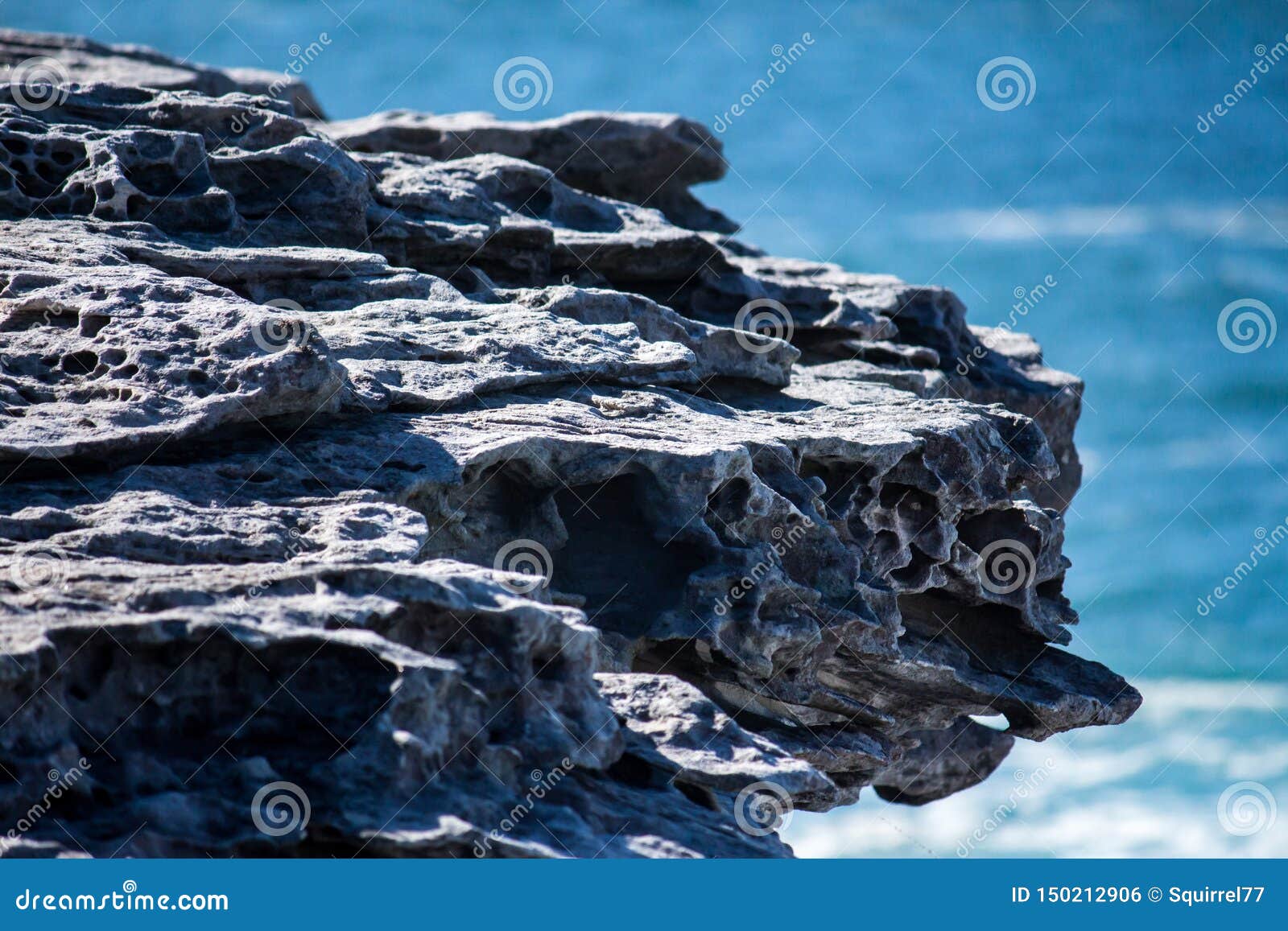 Oceanside Rocky Cliff Top with Blue Coastal Sea in Background Stock ...
