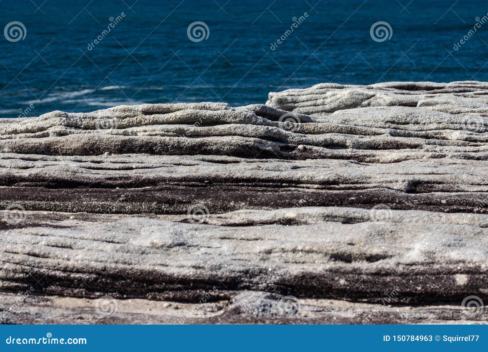 Oceanside Rocky Cliff Top Sandstone Wave Ridges with Blue Coastal Sea ...