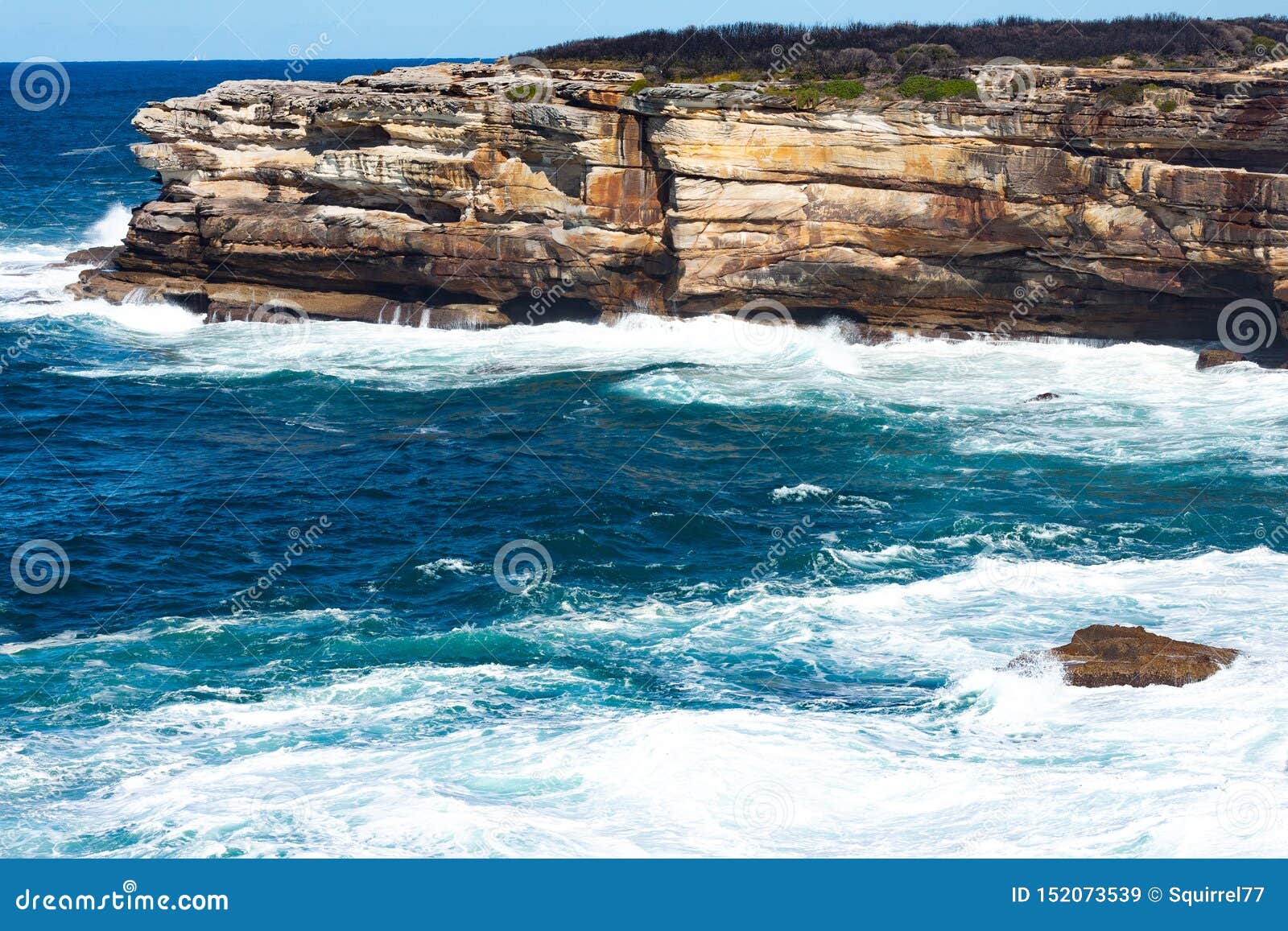 Oceanside Rocky Sandstone Cliff with Blue Sea Water Waves Creating ...