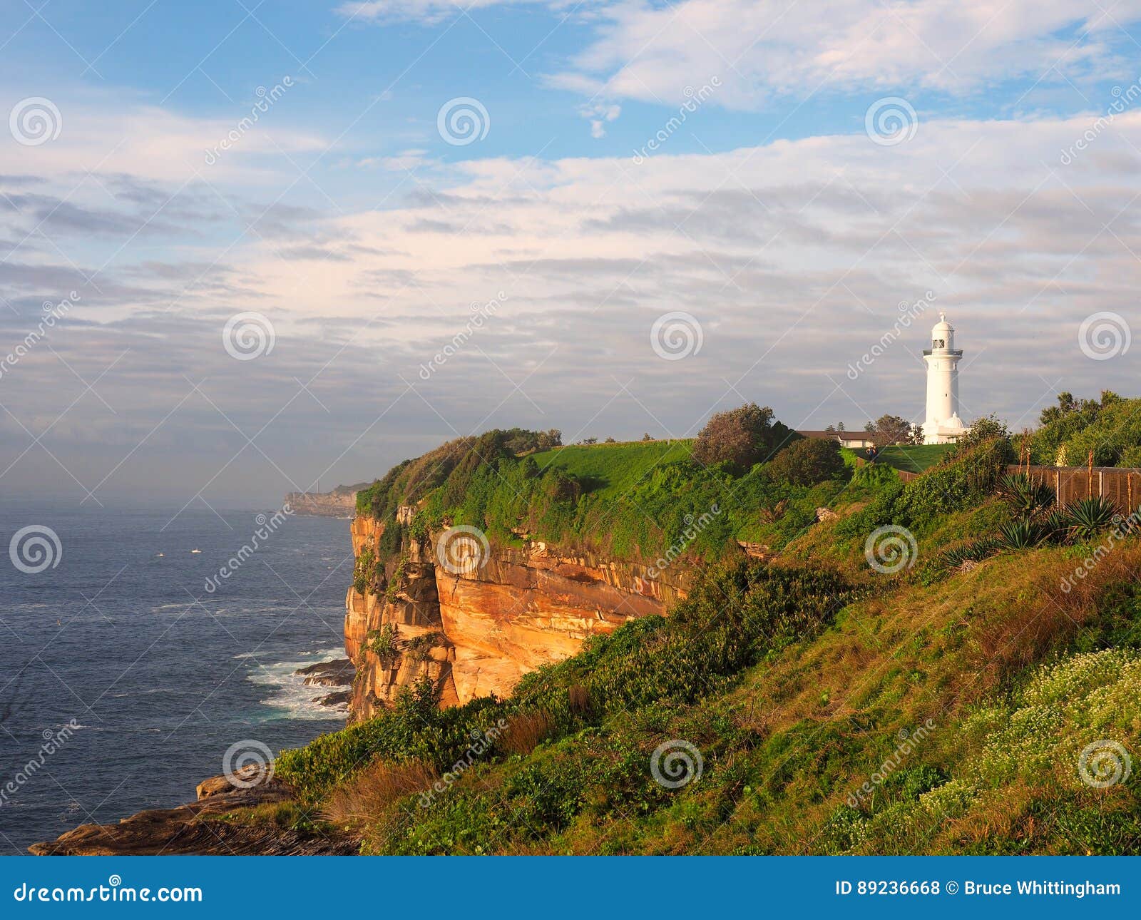 Ocean Cliffs with a White Lighthouse Stock Photo - Image of sandstone ...