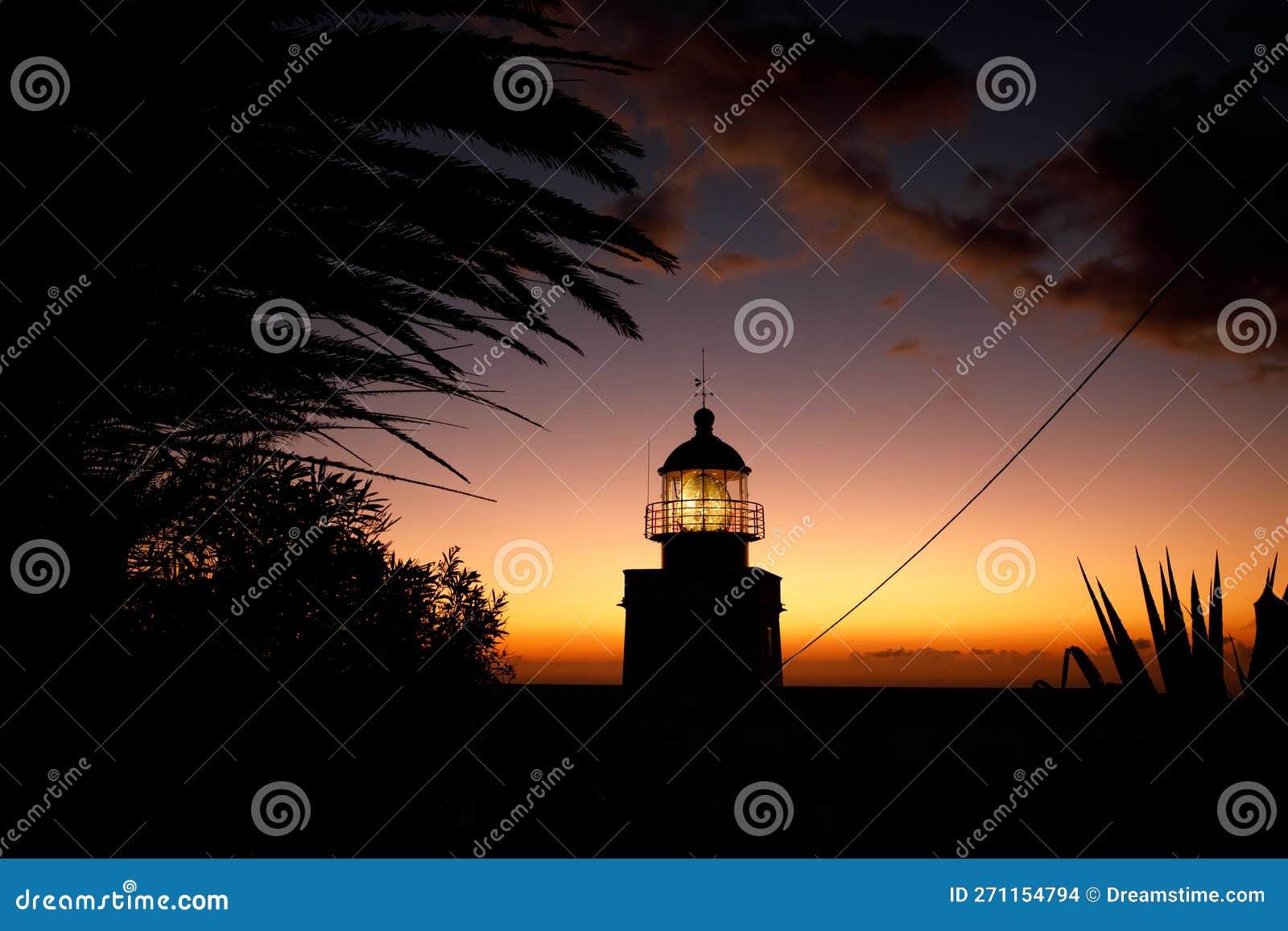 Ocean Lighthouse during the Sunset. Dramatic Clouds on the Background ...