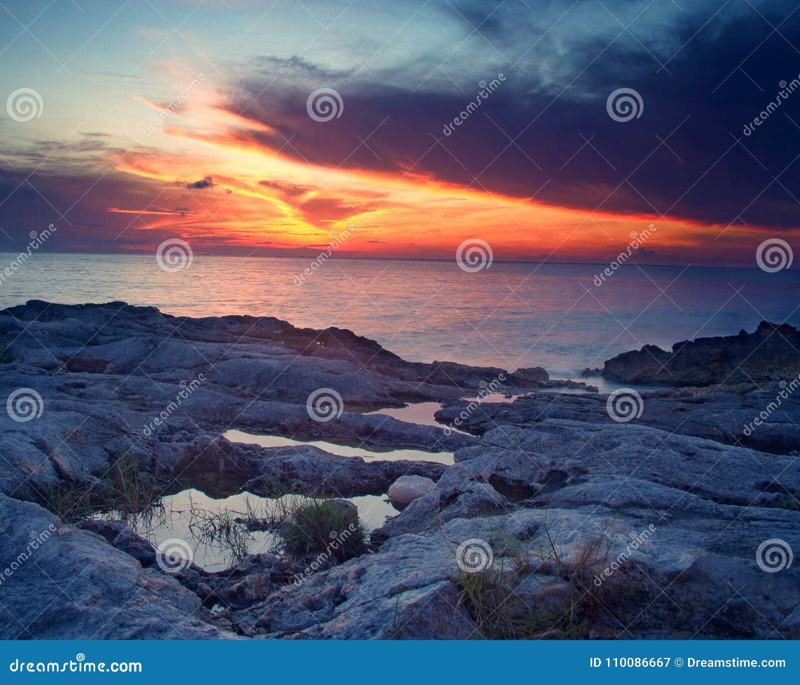 Ocean Sunset Reflected Off Rocks Stock Image - Image of stones, summer ...