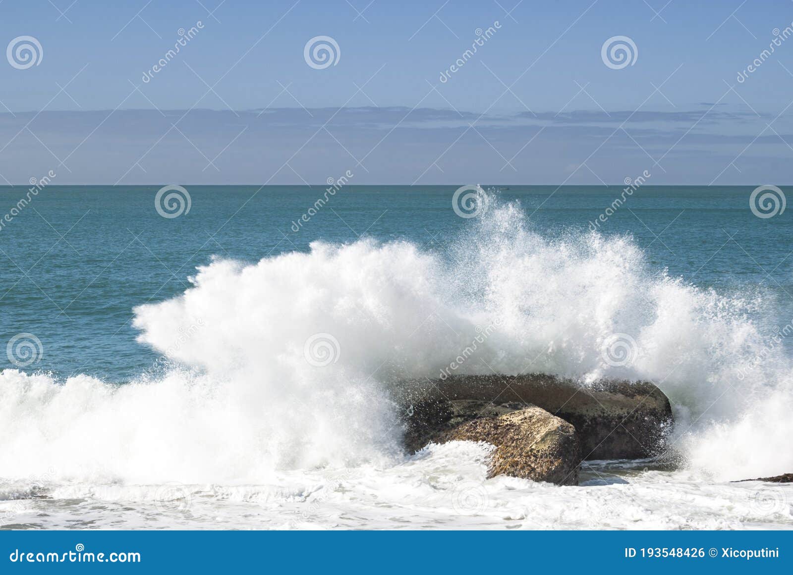 Ocean Wave Breaking in Splash Over Rock on the Beach Stock Photo ...