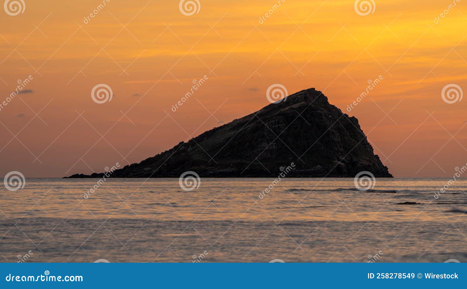 Ocean Waves Approaching a Big Stone by the Shore Captured at Sunset ...