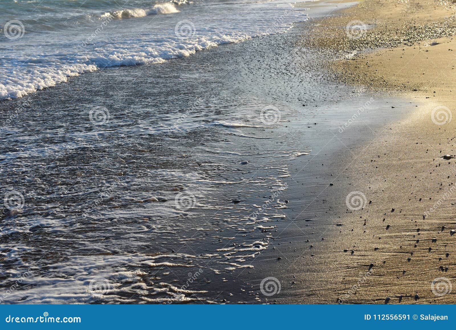 Ocean waves on sandy beach stock image. Image of beach - 112556591