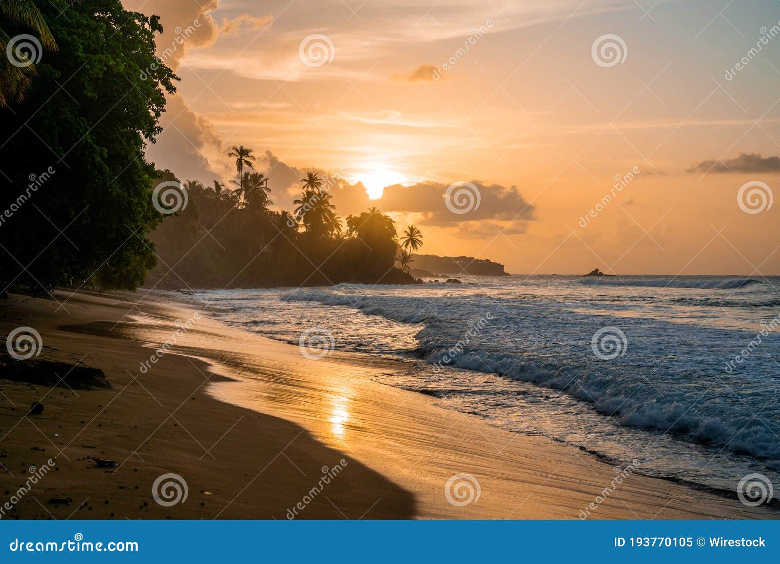 Ocean Waves Hitting the Sandy Beach and Gleaming Under the Sunset Stock ...