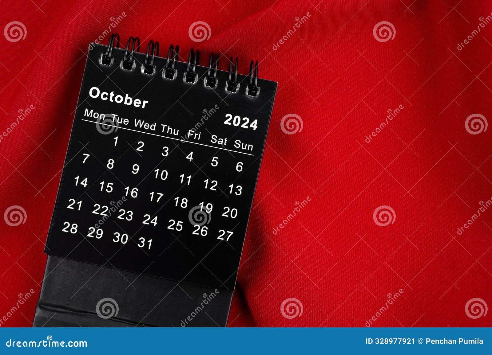 October 2024 Black Spiral Desktop Calendar on Red Textile Stock Image ...