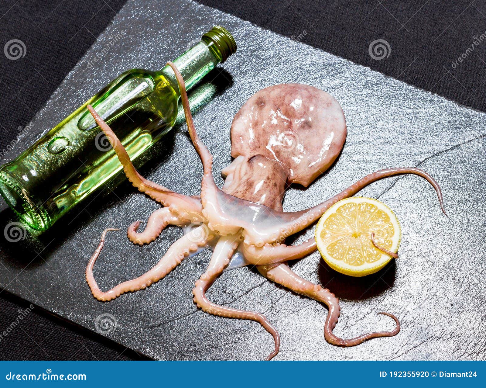 Octopus Holds Wine with Lemon Stock Photo - Image of diet, cutlery ...