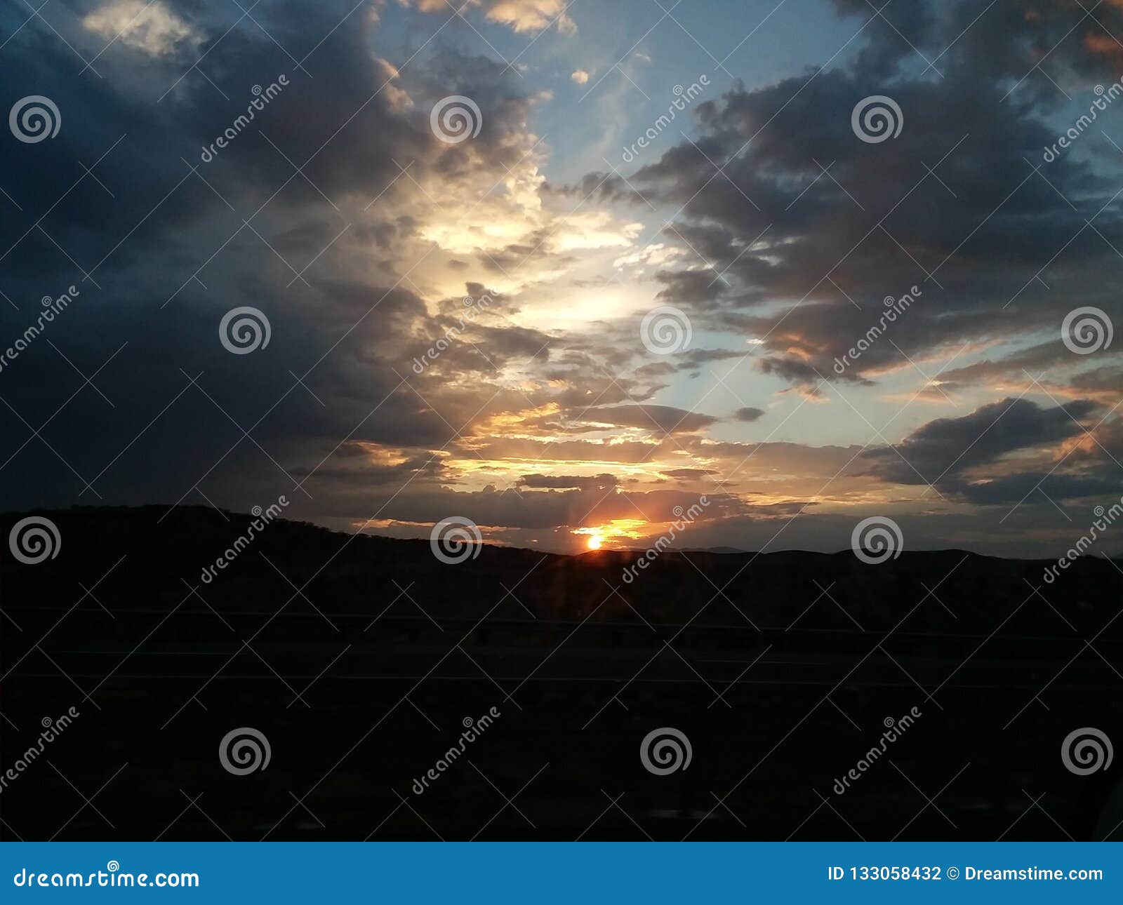 Odd clouds at sunset stock photo. Image of view, sunset - 133058432