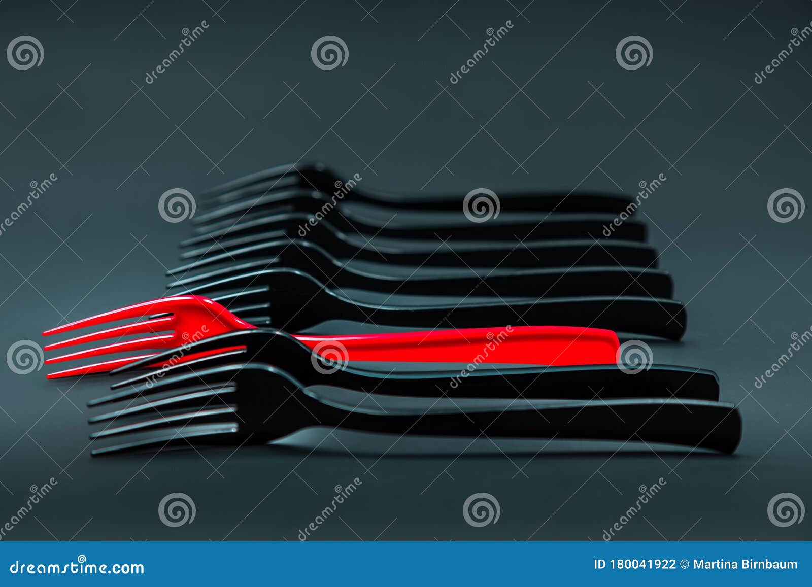 The Odd One, Red Fork between Black Forks. Selective Focus Stock Photo ...