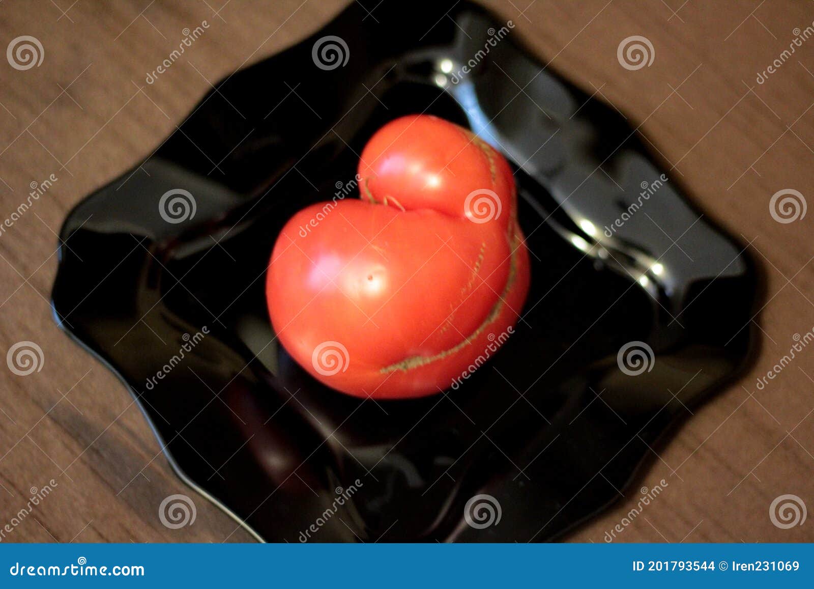 Red Tomato with an Unusual Shape on a Plate Stock Photo - Image of ...