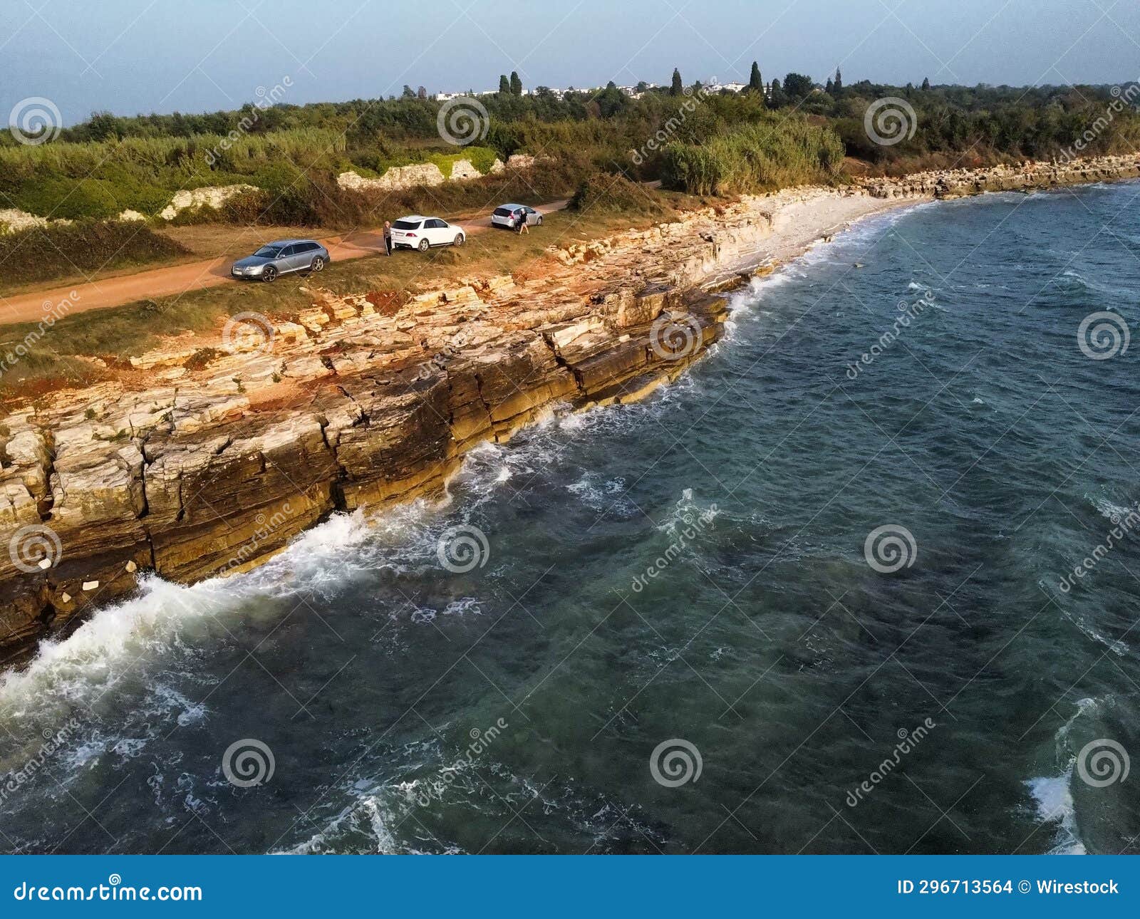 Off-road Vehicles Driving Along the Beachfront, with the Ocean in the ...