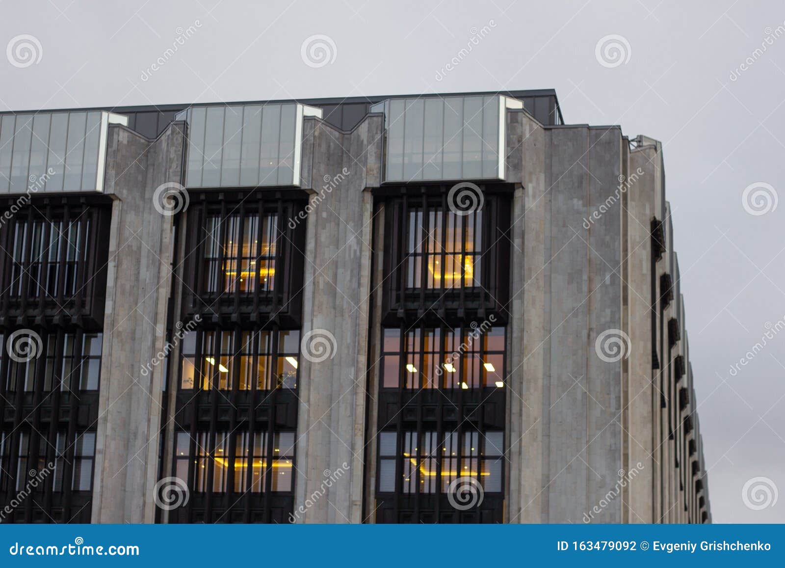 Office Building Made of Stone. with Lighted Offices Stock Photo - Image ...