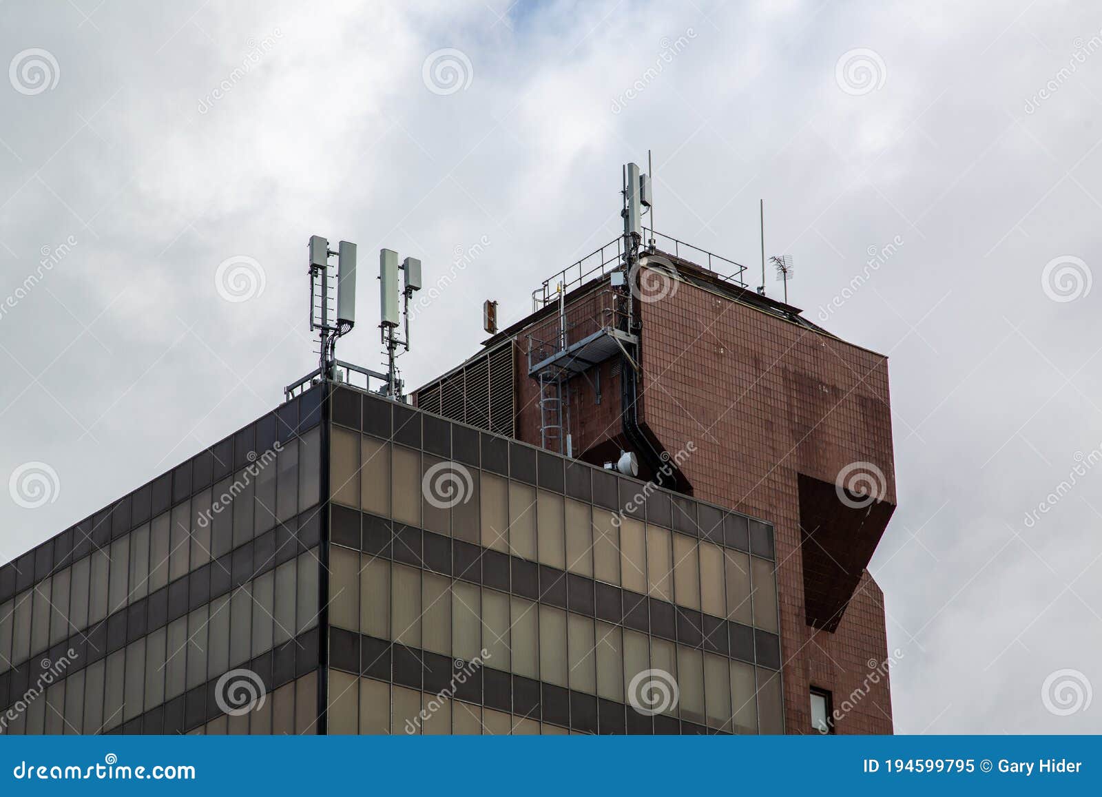 An Office Building with Mobile Phone Antennas and Masts on the Roof ...