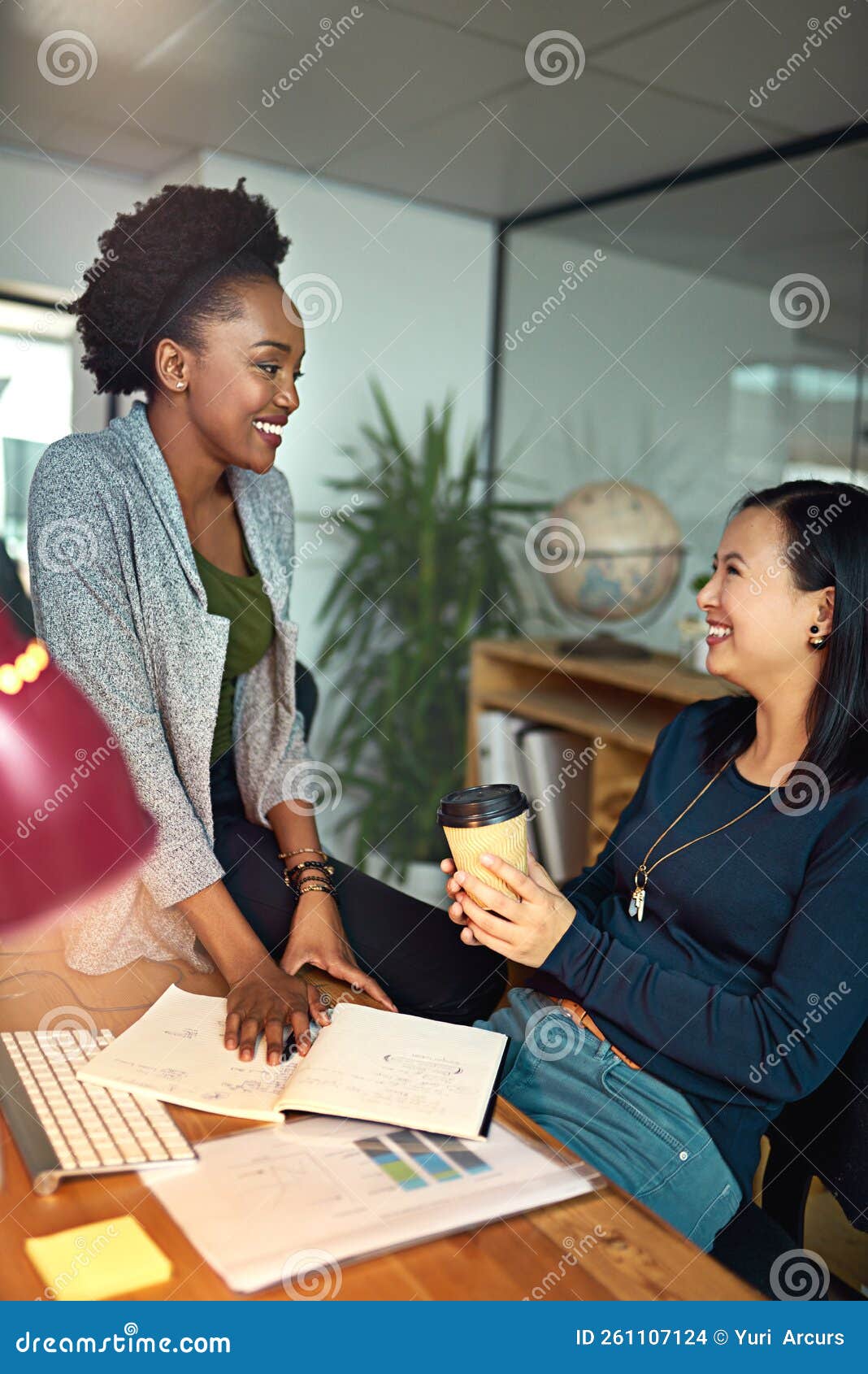Office Chatter. Two Young Designers Talking in the Office. Stock Photo ...