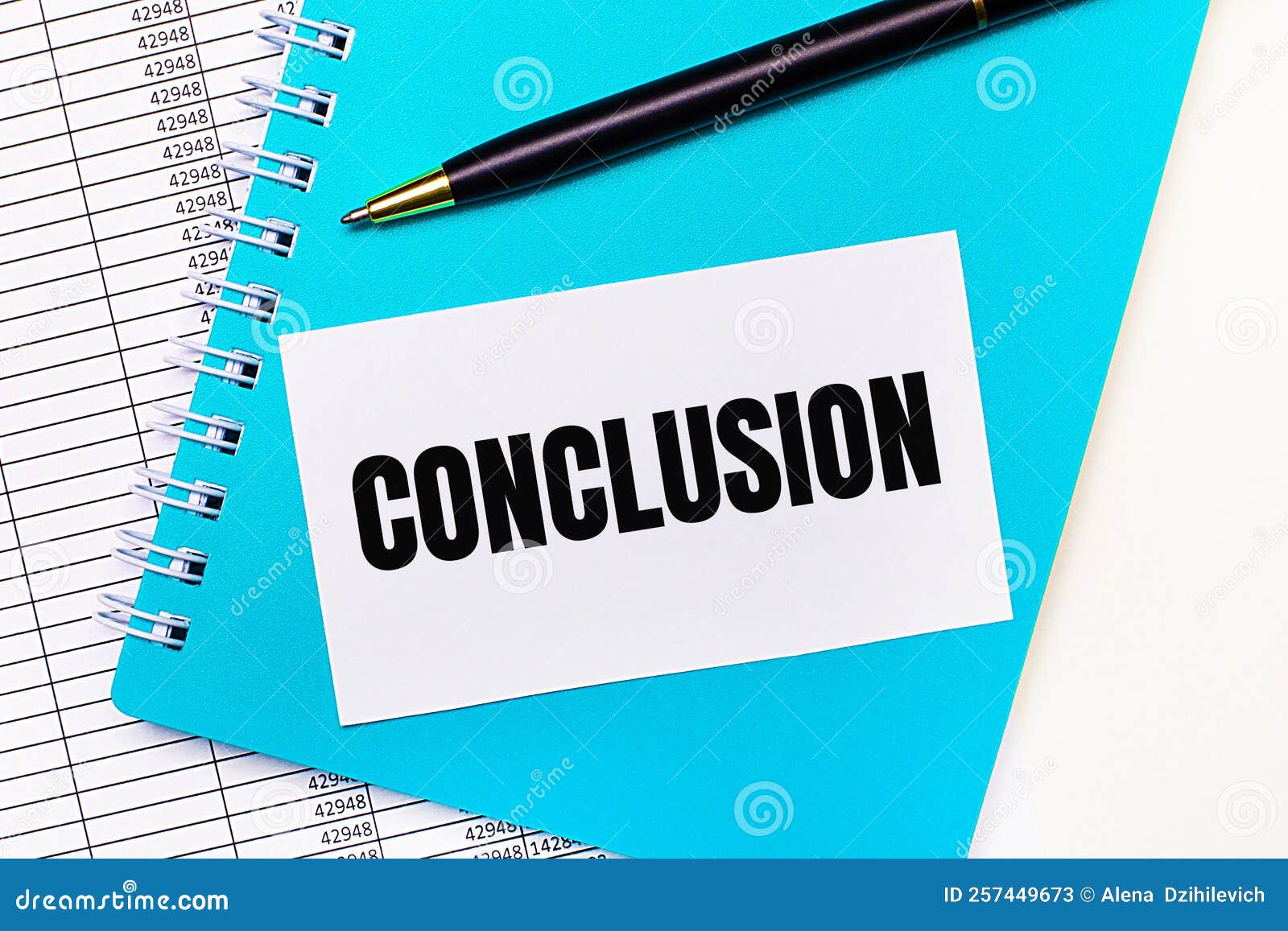 On the Office Desk There are Reports, a Blue Notepad, a Black Pen, and ...