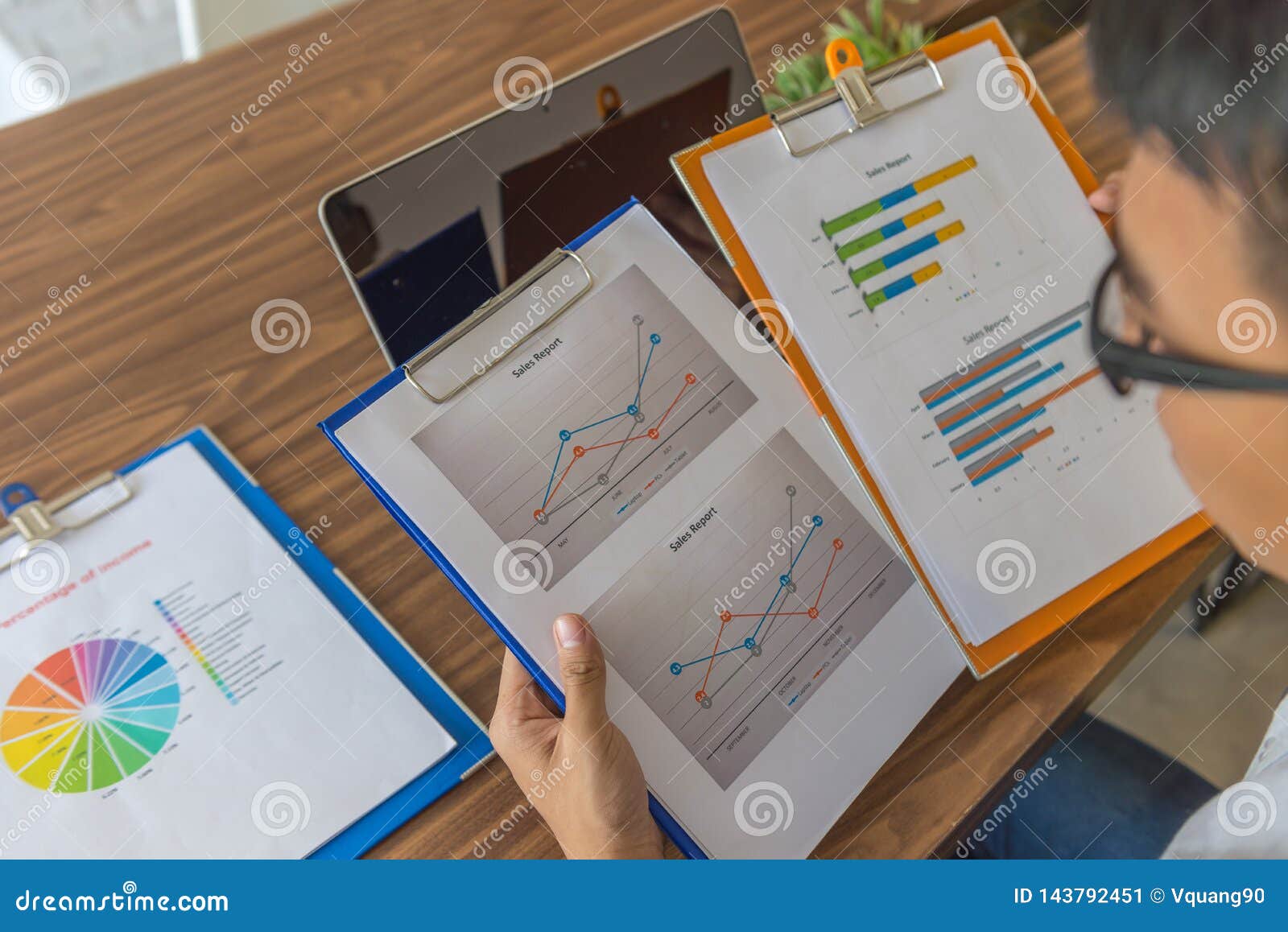 Office Employee Checking the Data on Sales Reports in Office Stock ...