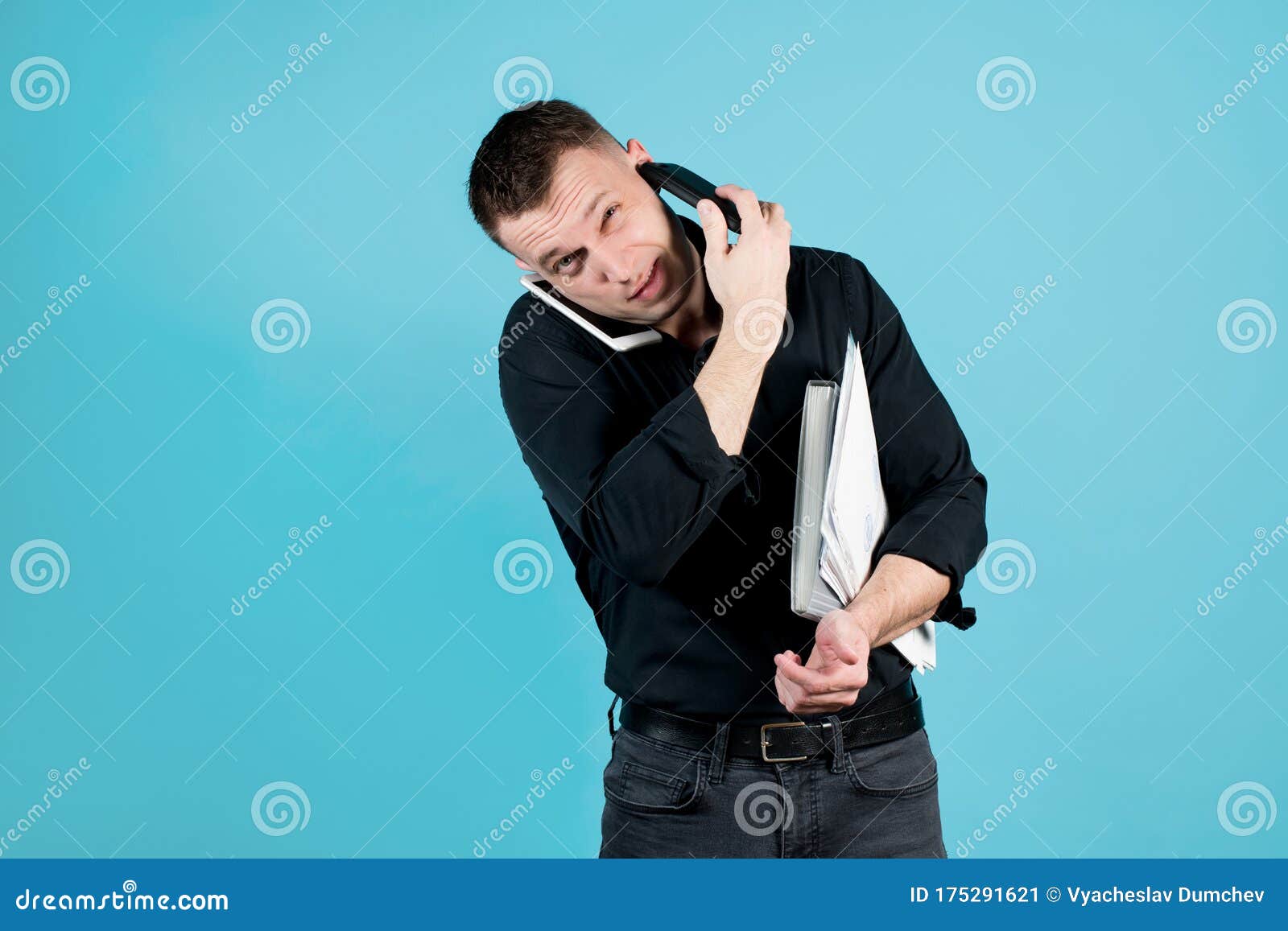Office Employee Speaks on Phones at the Same Time and Holds a Stack of ...