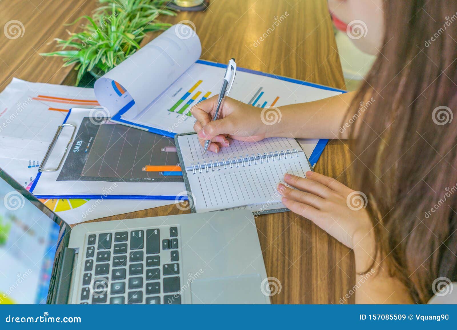 Woman Manually Writing on Notebook while Working on Laptop Stock Image ...