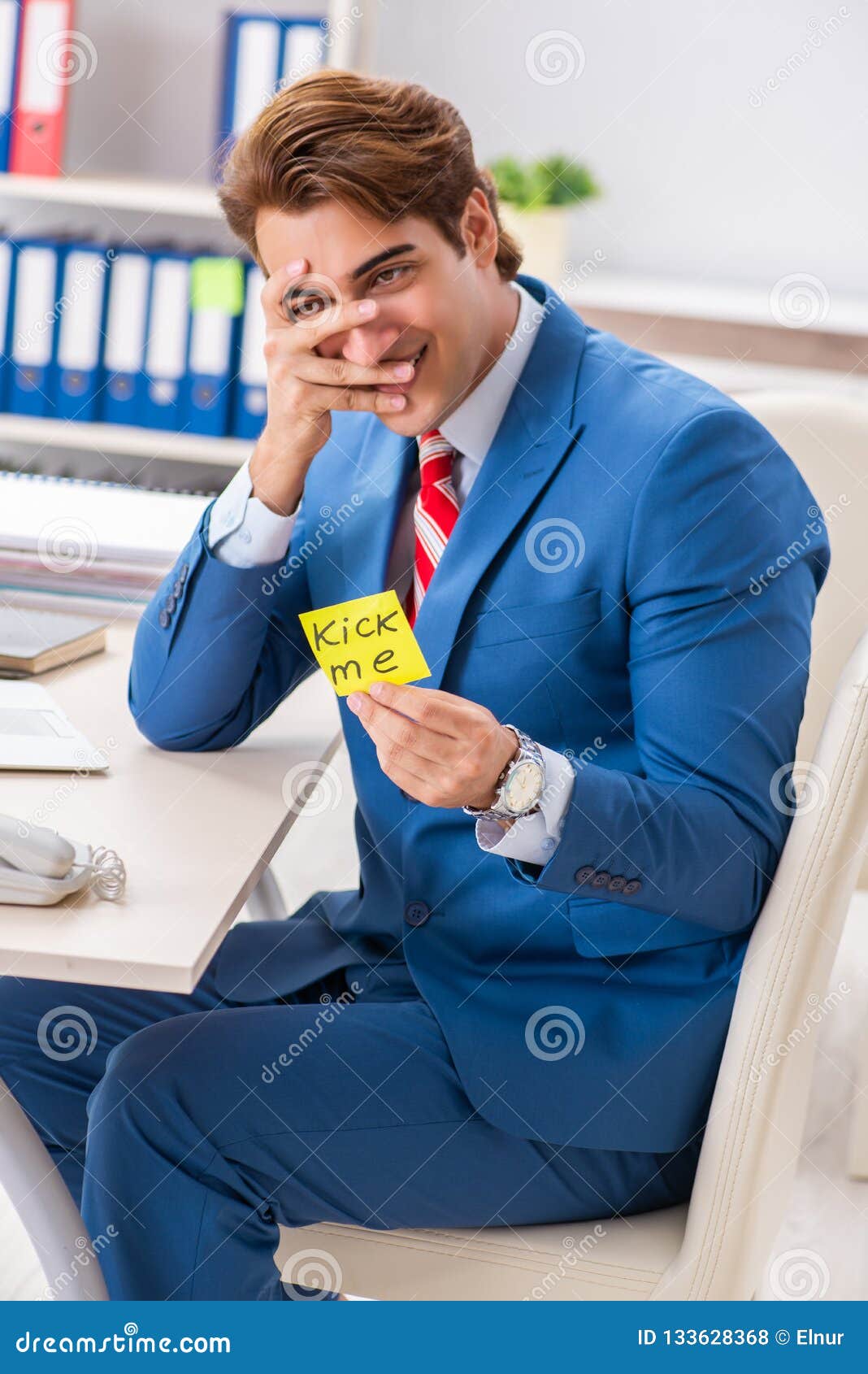 The Office Prank with Kick Me Message on Sticky Note Stock Photo ...