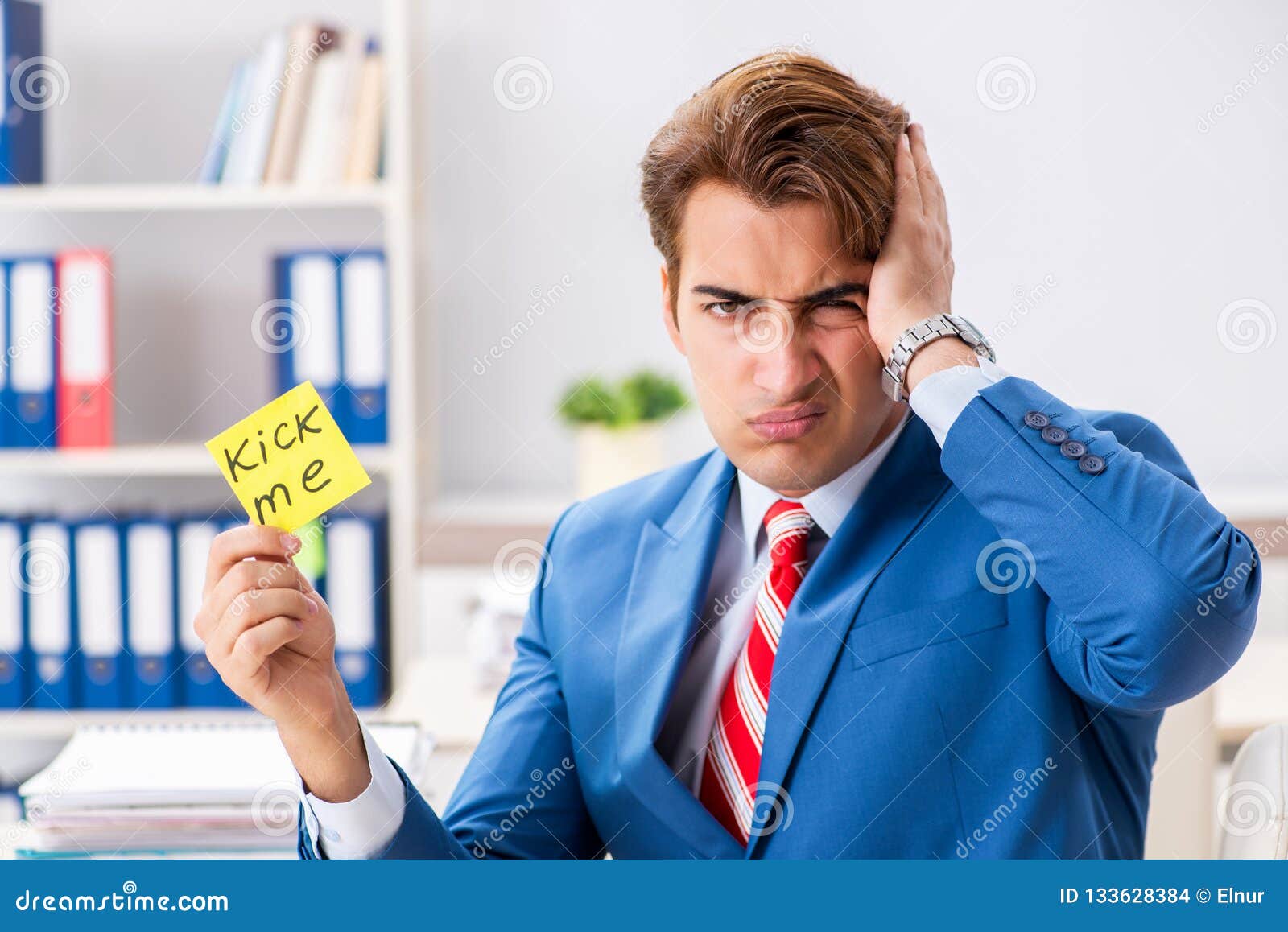 The Office Prank with Kick Me Message on Sticky Note Stock Photo ...