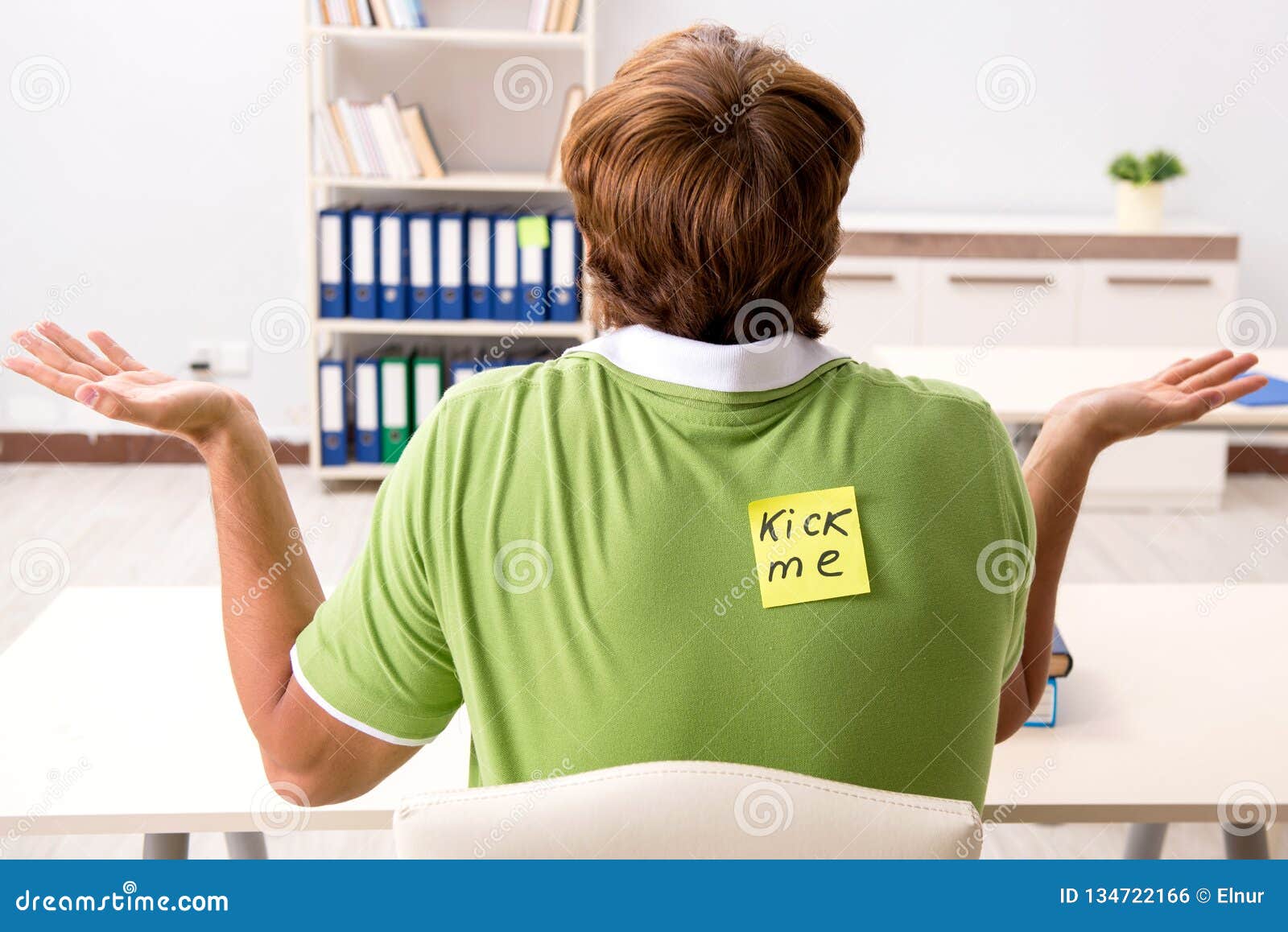 The Office Prank with Kick Me Message on Sticky Note Stock Photo ...