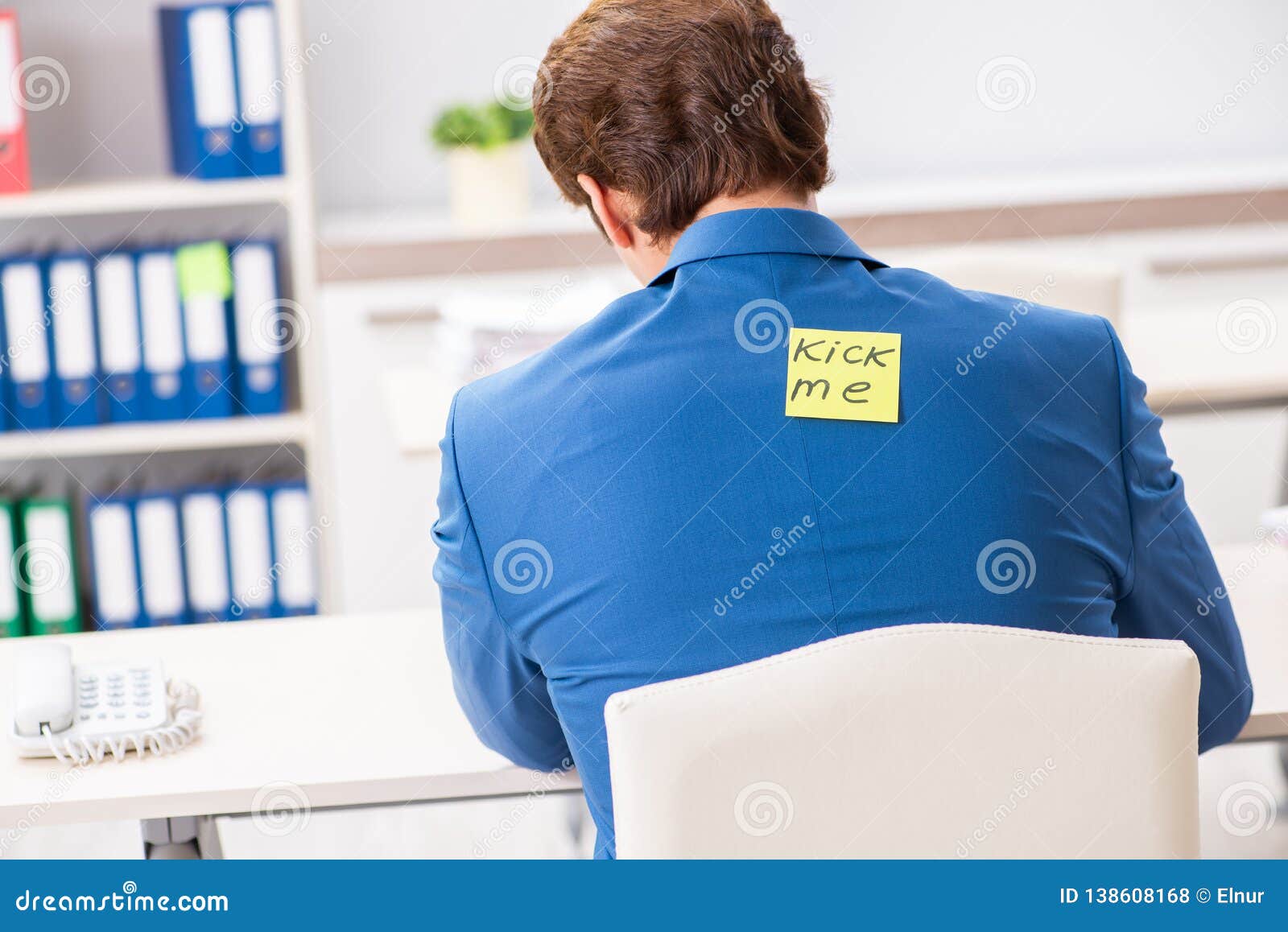 The Office Prank with Kick Me Message on Sticky Note Stock Photo ...