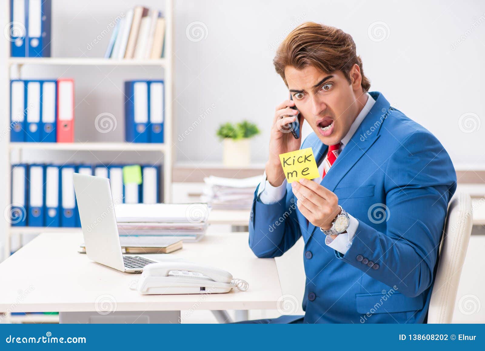 The Office Prank with Kick Me Message on Sticky Note Stock Photo ...