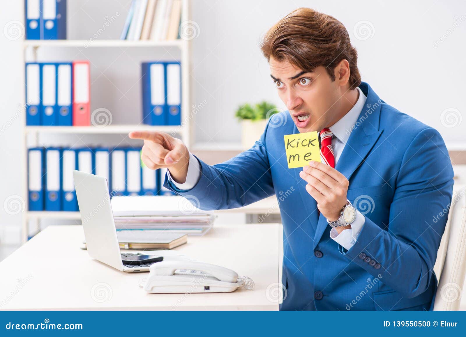 The Office Prank with Kick Me Message on Sticky Note Stock Photo ...
