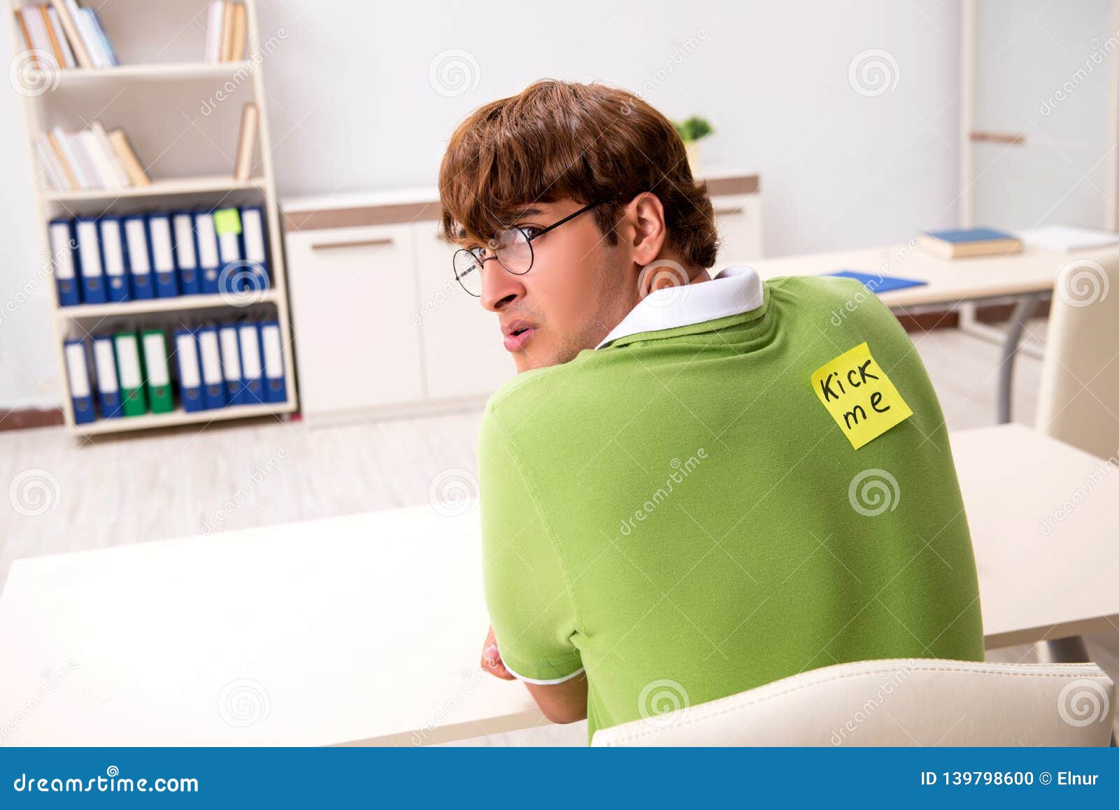 The Office Prank with Kick Me Message on Sticky Note Stock Photo ...