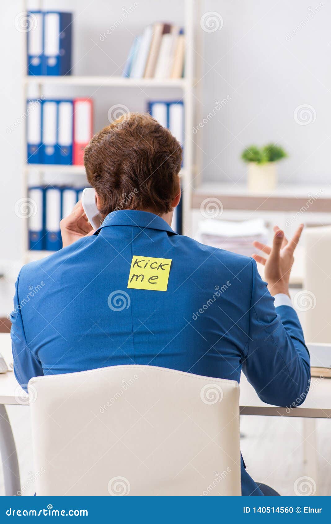 The Office Prank with Kick Me Message on Sticky Note Stock Photo ...