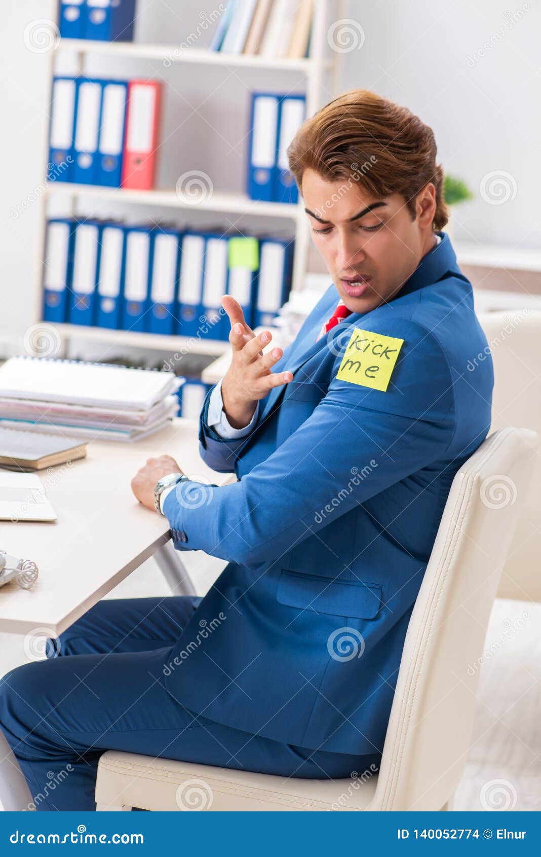 The Office Prank with Kick Me Message on Sticky Note Stock Photo ...