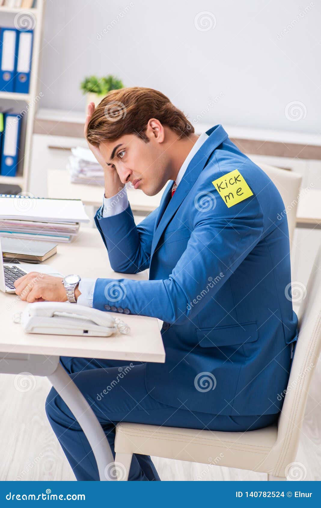 The Office Prank with Kick Me Message on Sticky Note Stock Photo ...