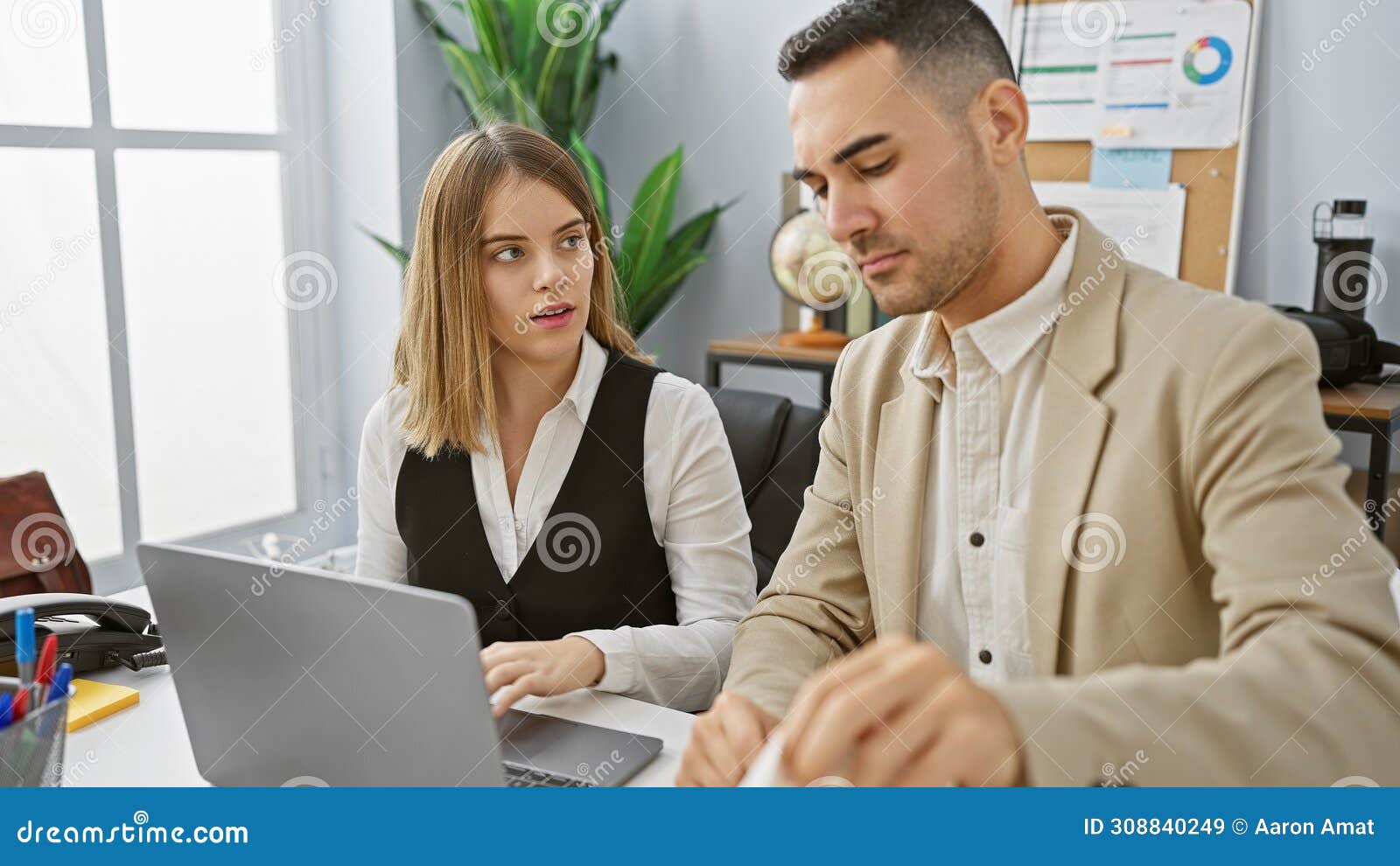 In an Office Setting, a Professional Man and Woman Work Together, Collaborating on a Project ...