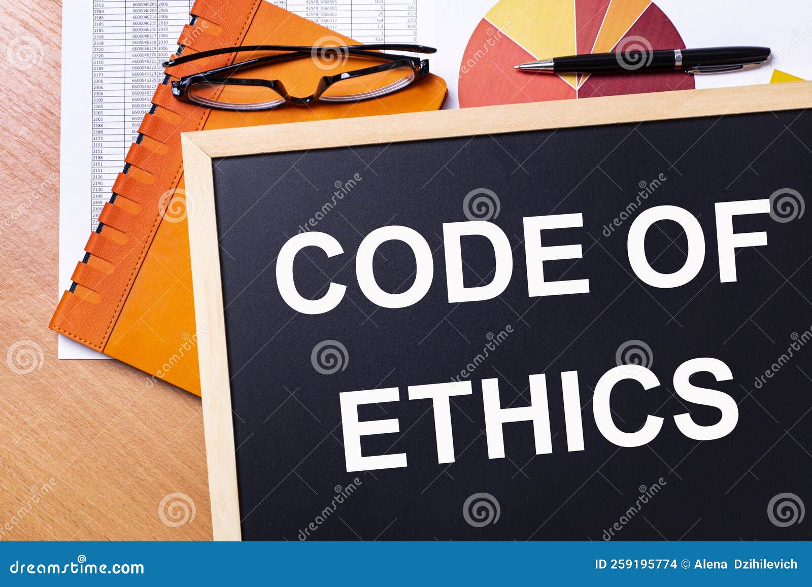 On the Office Table is an Orange Notepad, Black Glasses, a Pen and a ...