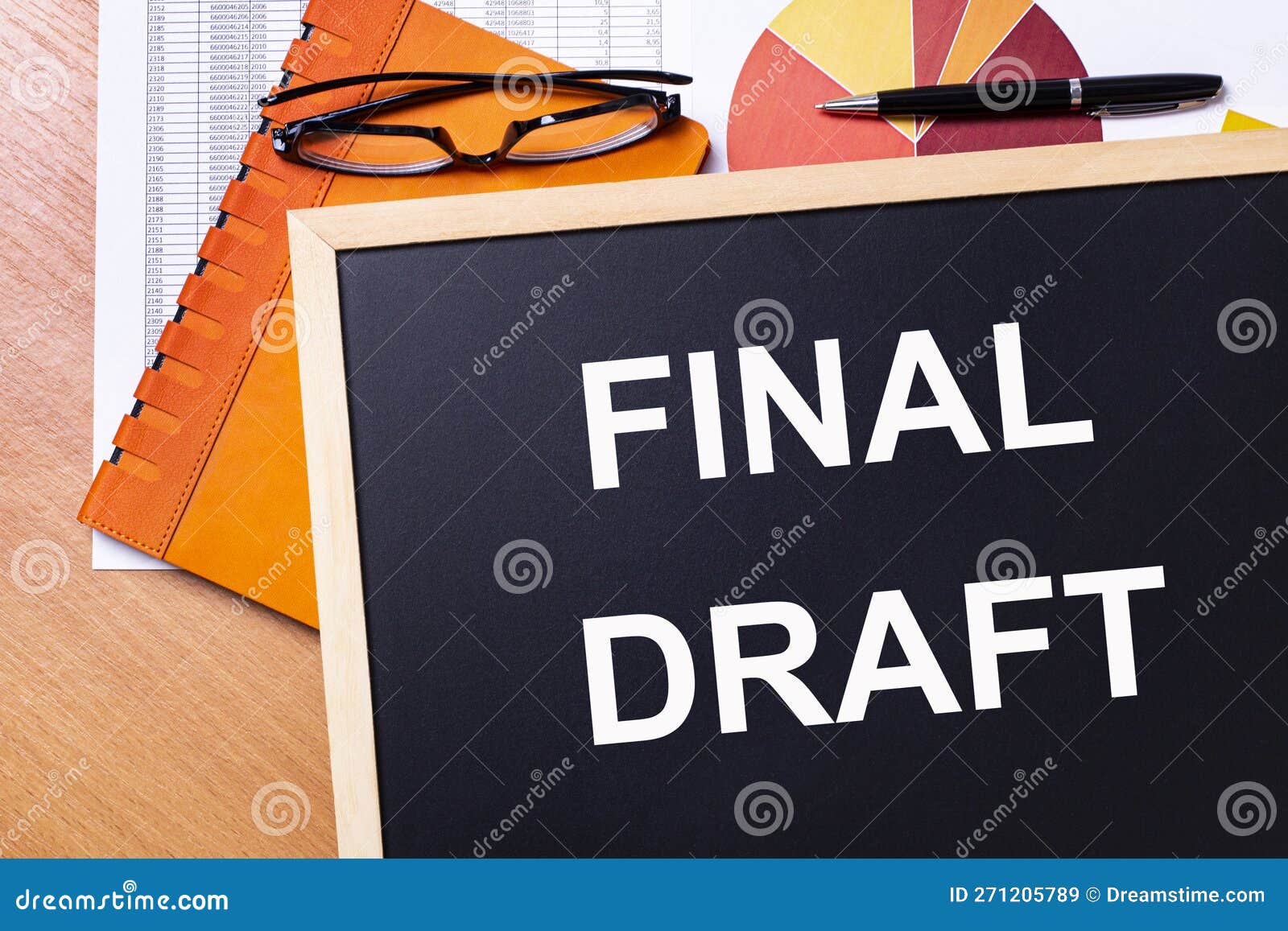 On the Office Table is an Orange Notepad, Black Glasses, a Pen and a ...