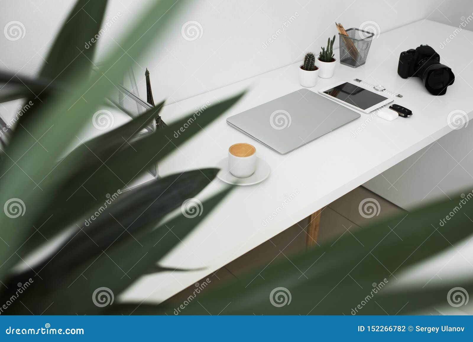 Office Table on Which Laptop, Coffee, Tablet, Camera and Other Items ...